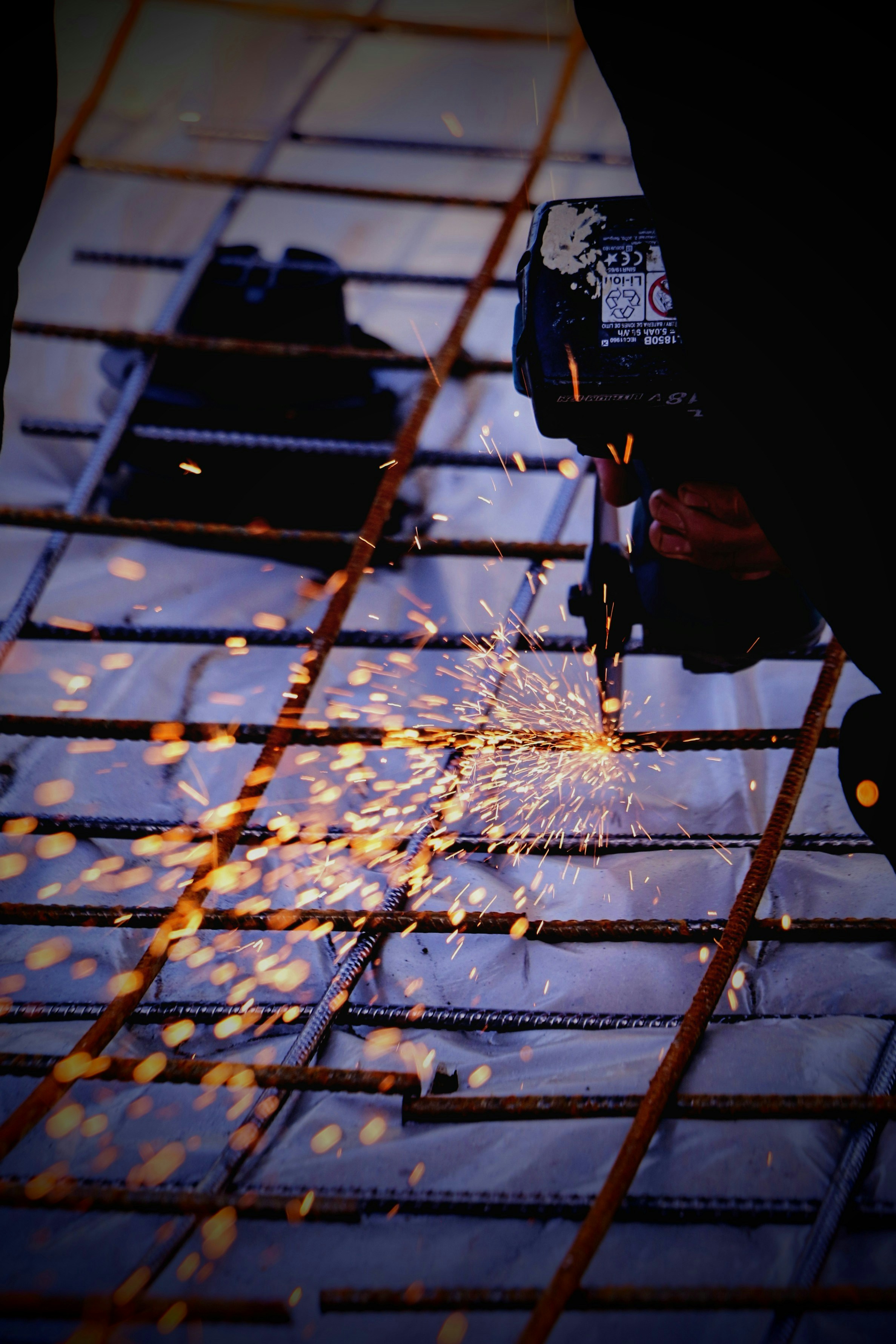A person using a grinder on a piece of metal photo – Free Human Image ...