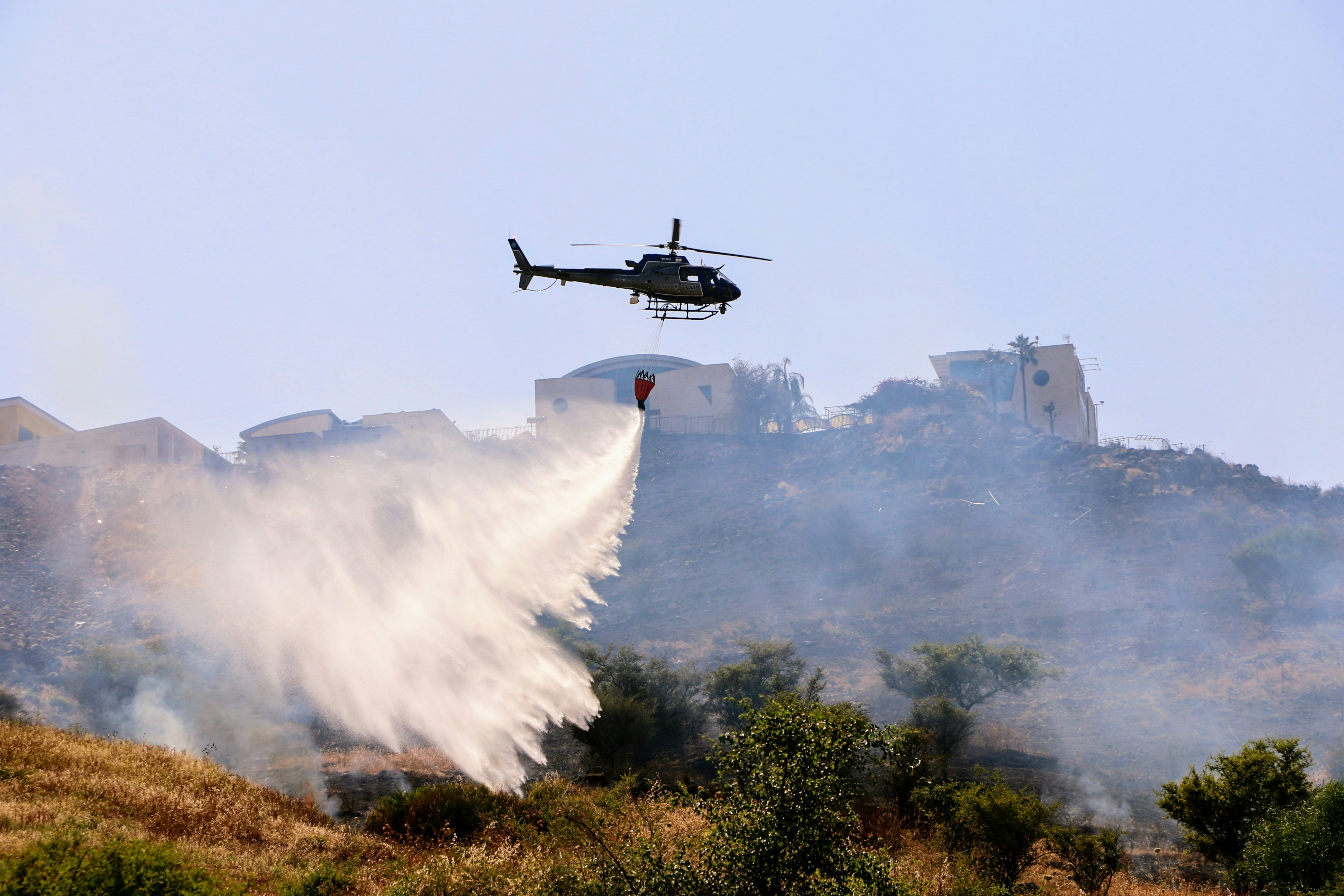 A helicopter dropping water onto a fire hydrant photo – Free Aircraft ...