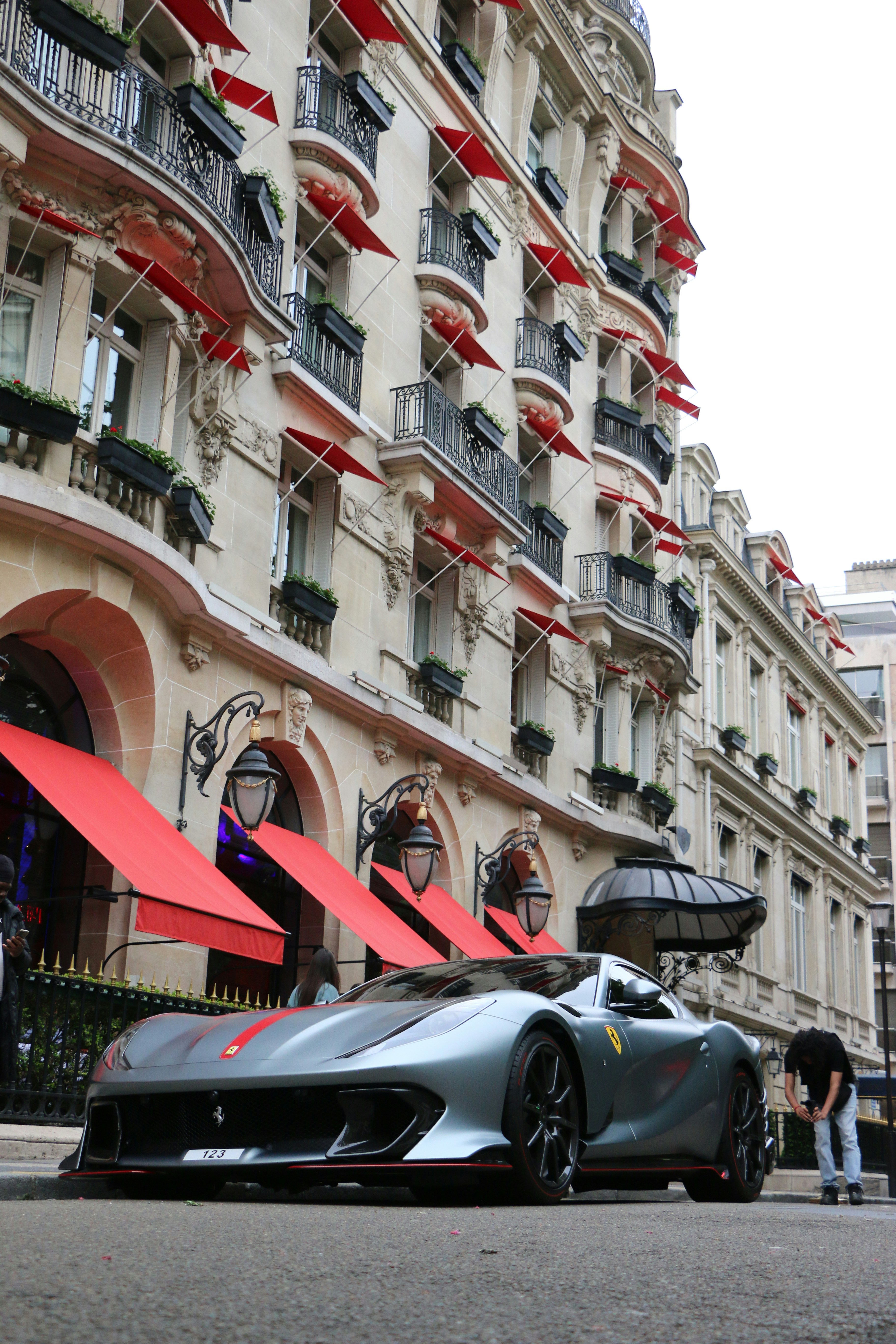 Ferrari on a Parisian Boulevard: Crimson Awnings Frame Elegant Facades
