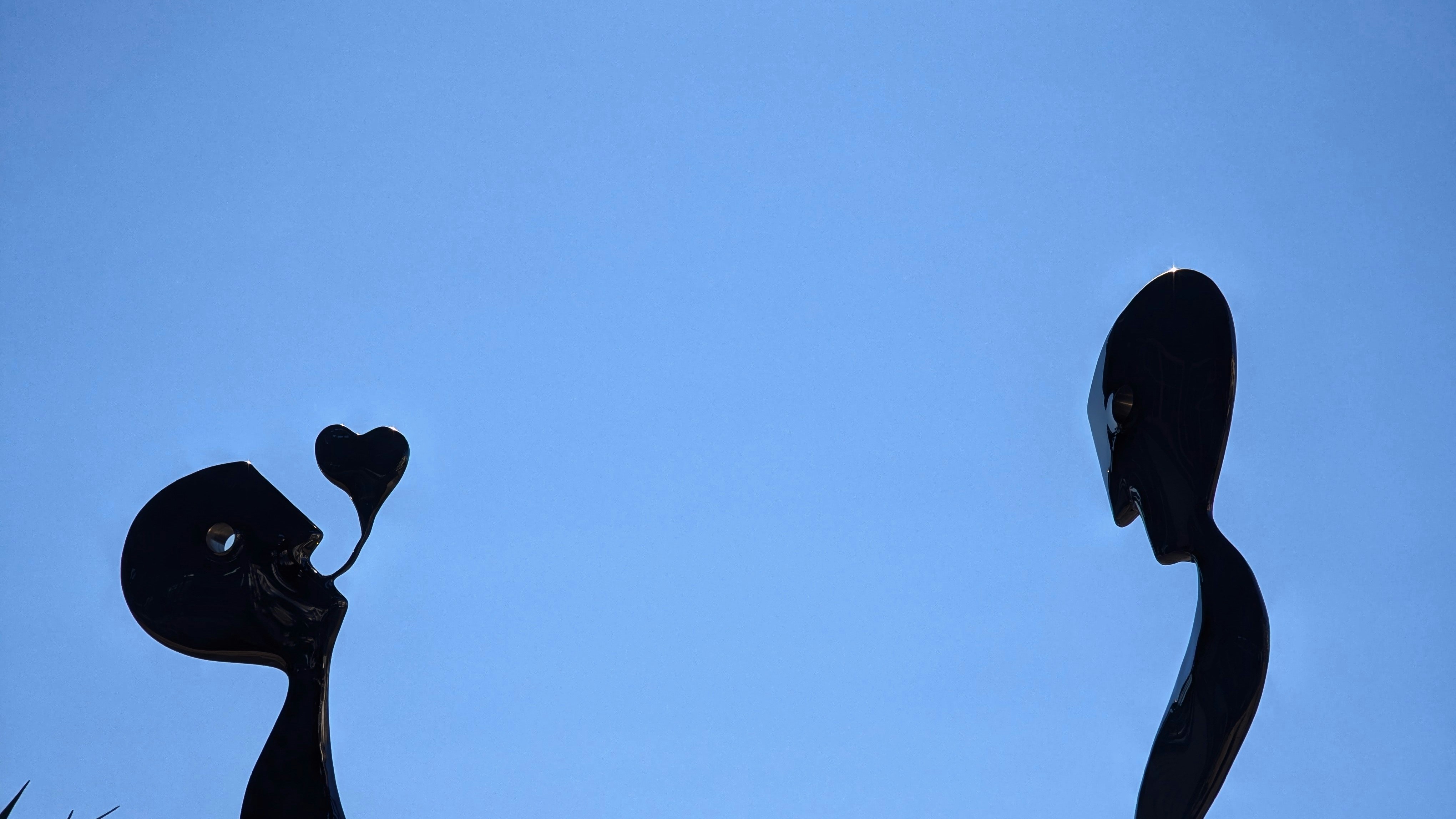 Heartbound Silhouettes Under a Pristine Blue Sky