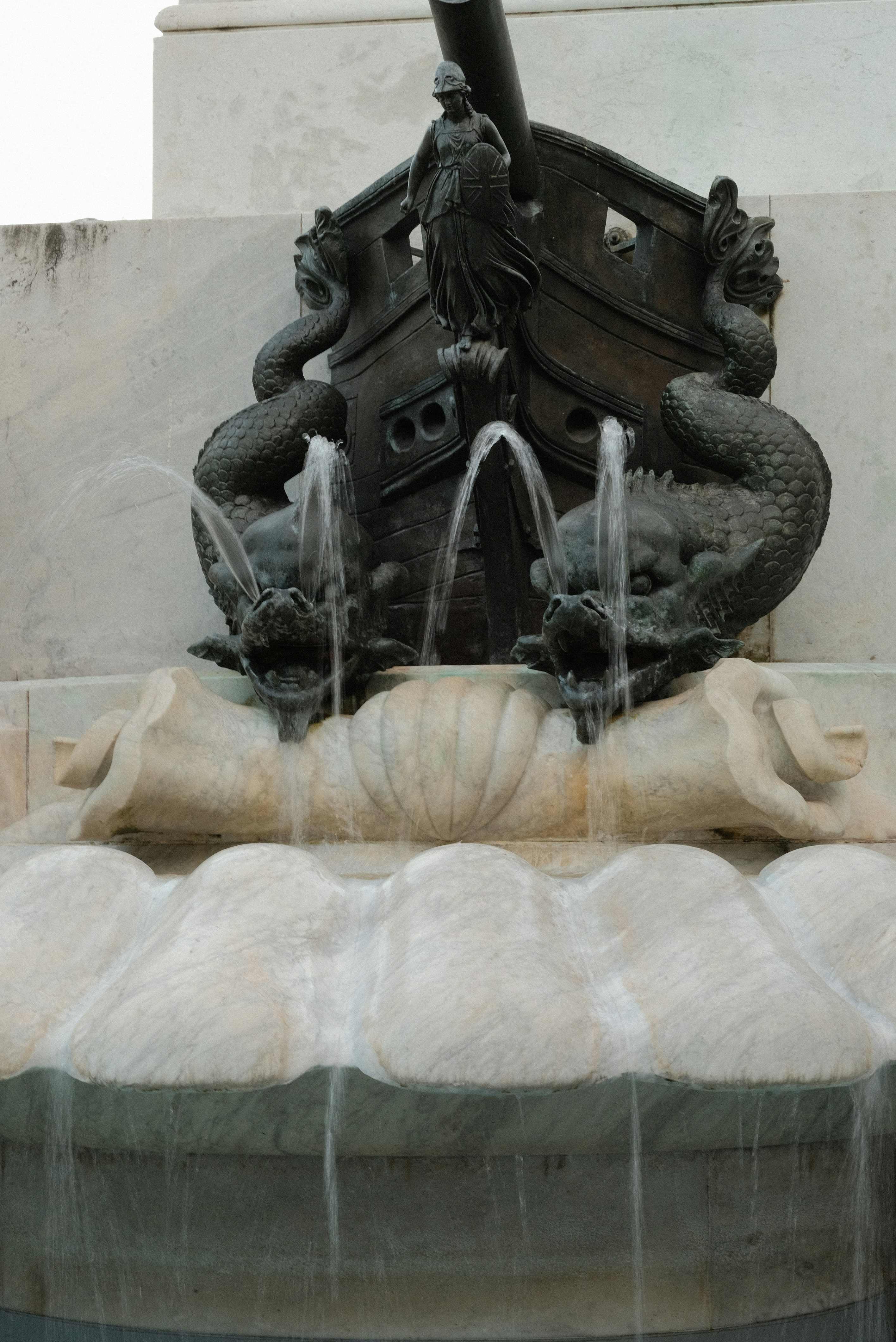 Stone Sentinel at the Dragon Fountain: Water Arcs Between Coiling Guardians