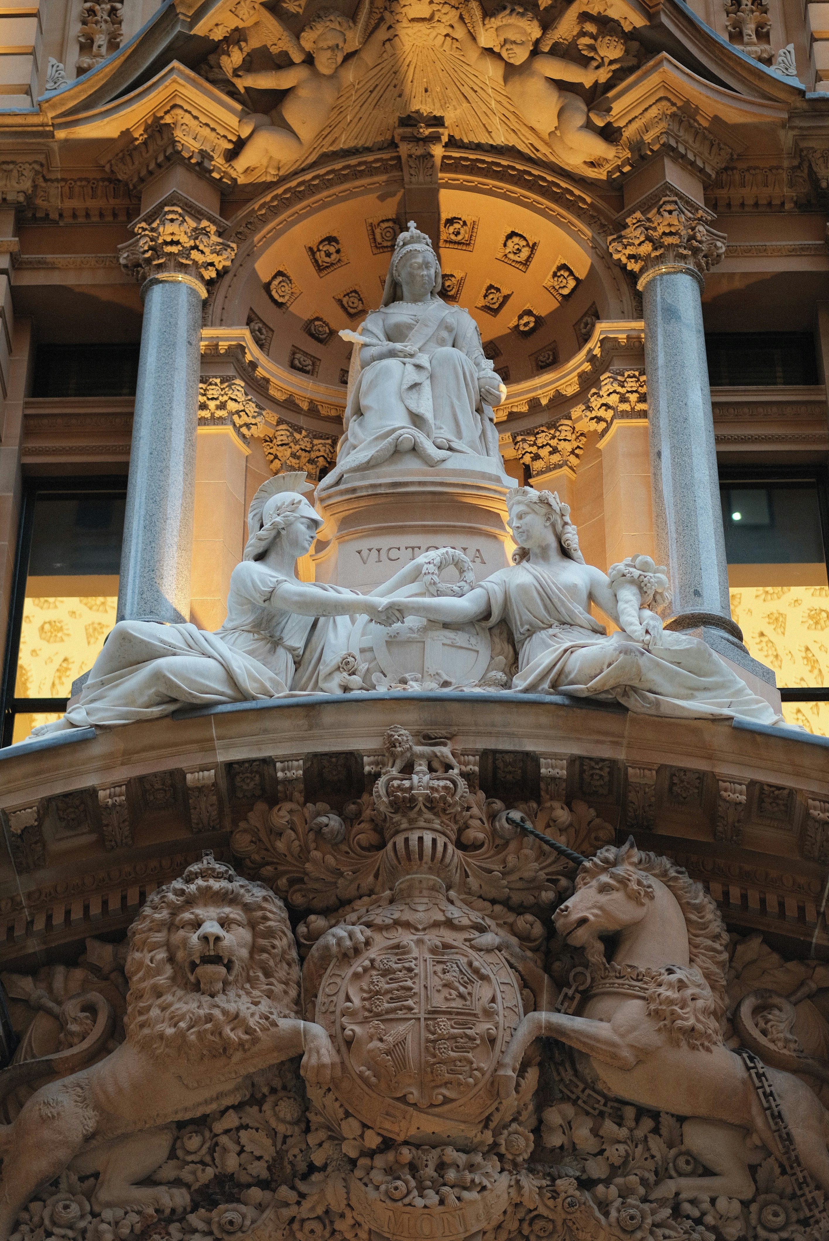 Statues and Crest: Carved Majesty Above the Portal