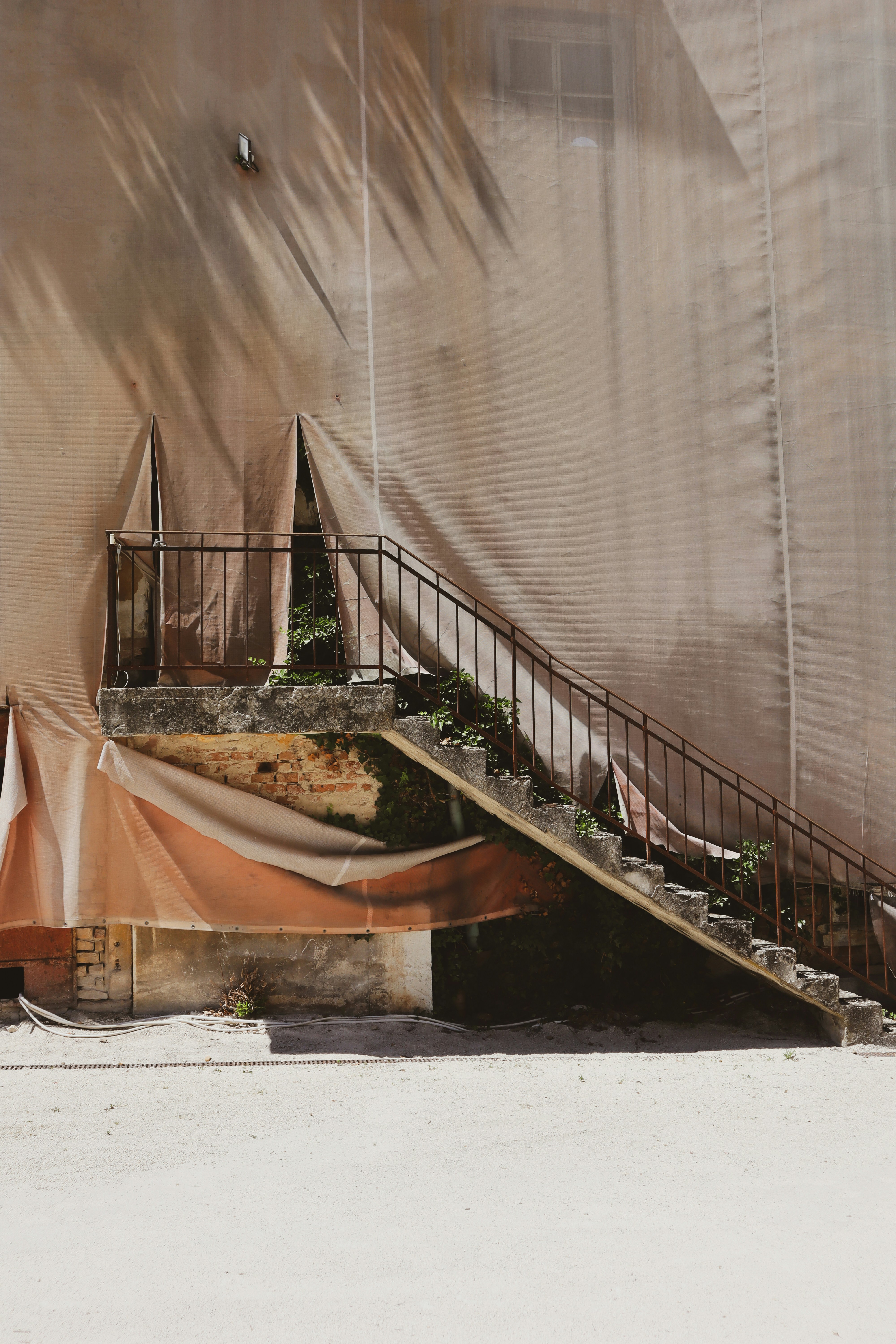 Sunlit Stairs Against a Draped Peach Facade