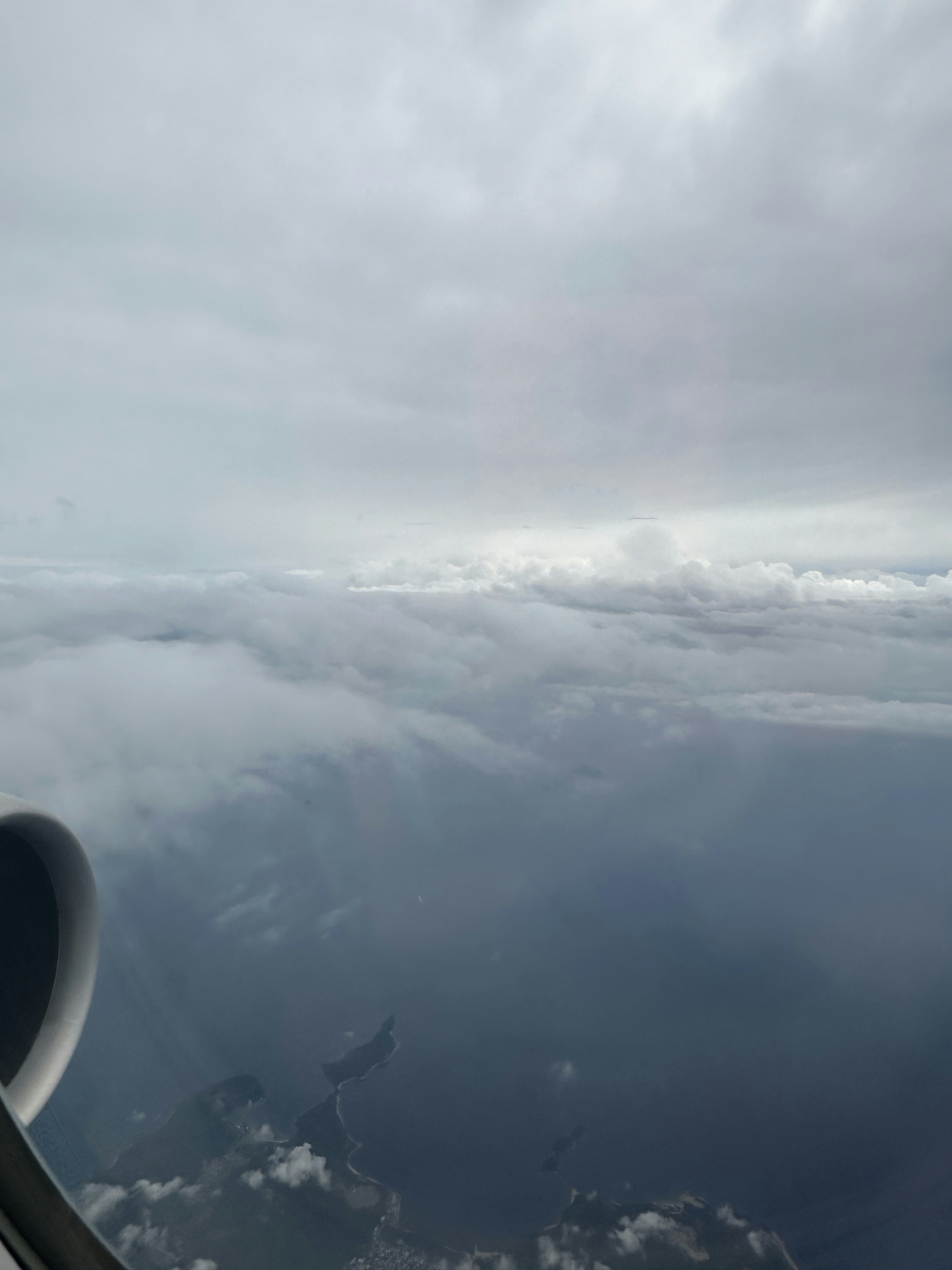 Window Seat Horizon: Cloud Strata Over a Dark Sea