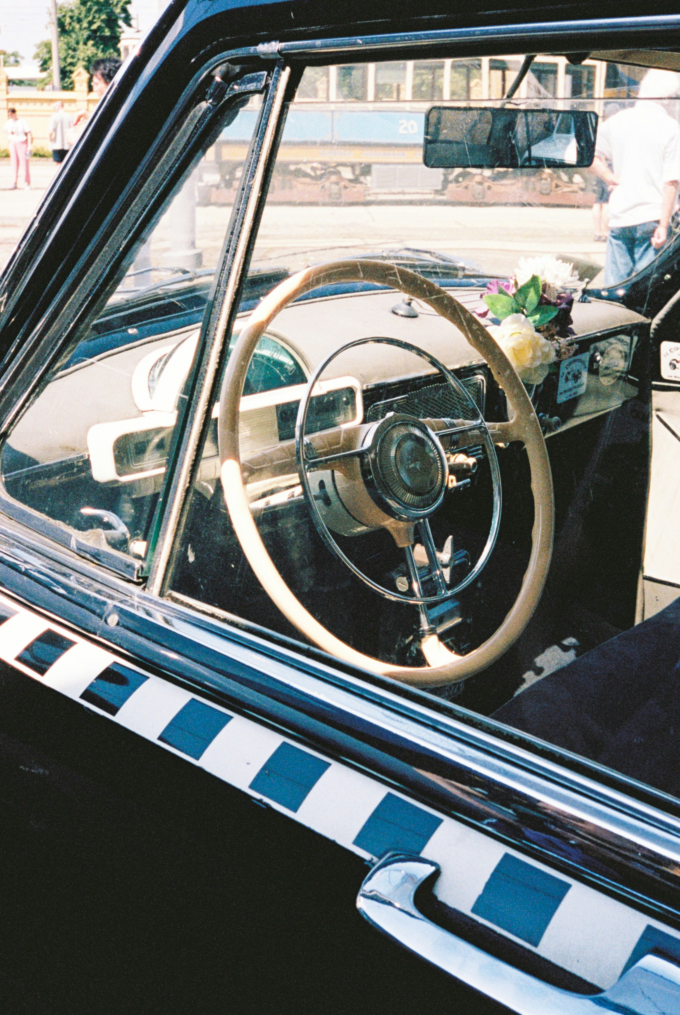 Chrome and Petals: a sunlit glance into a vintage car's quiet interior