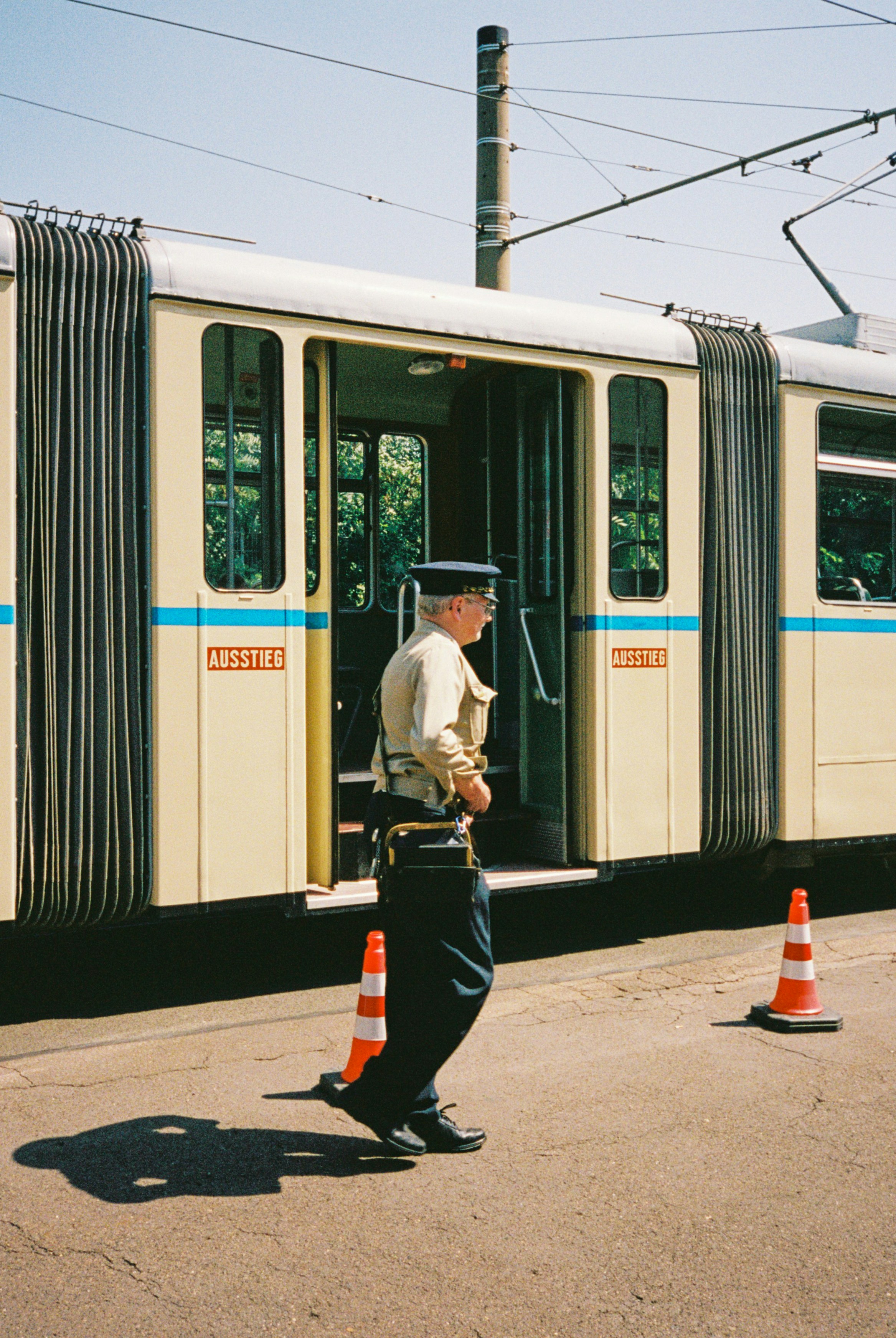 A train conductor walking past a train on the tracks photo – Free ...