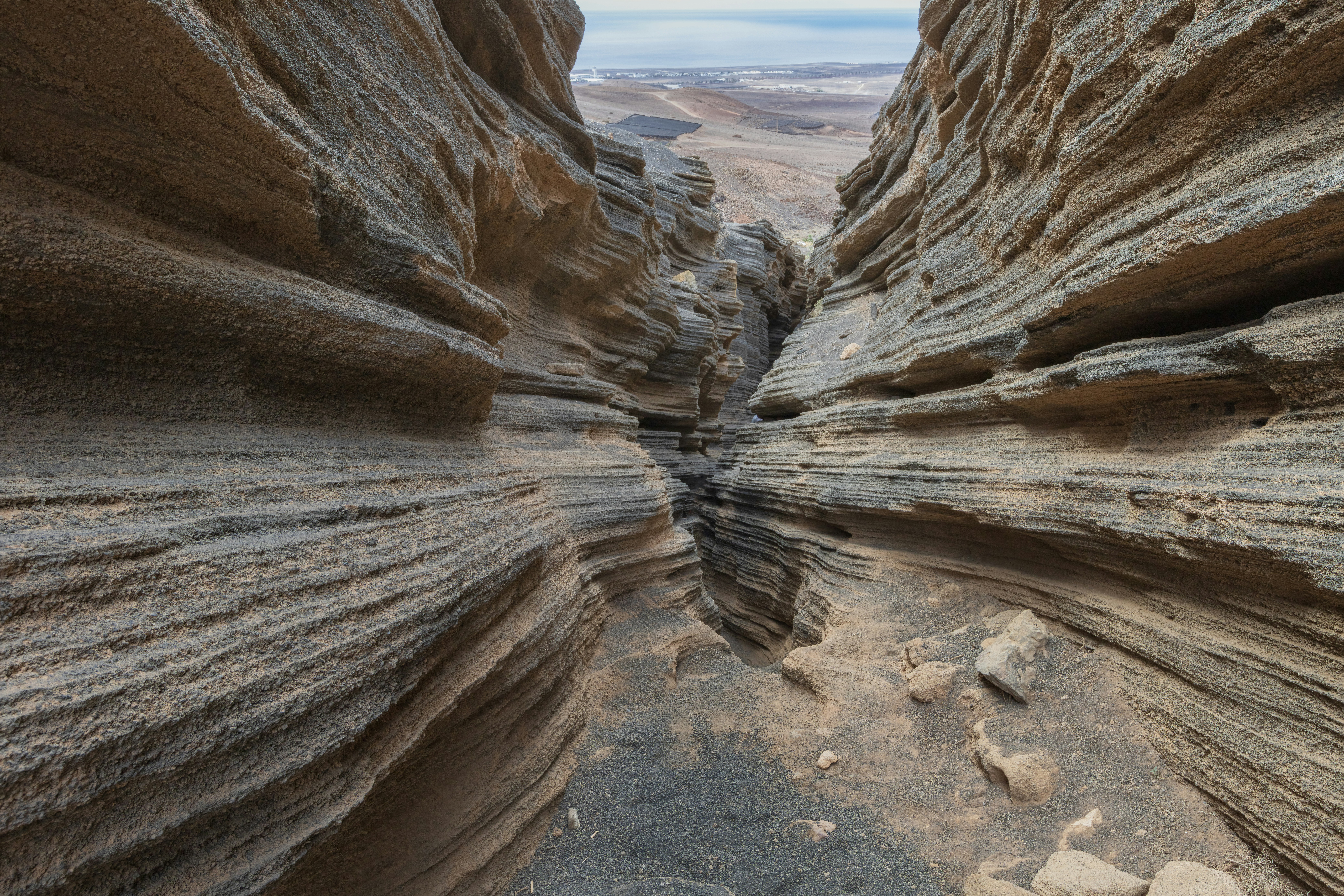Intricate rock formations carved by wind and water in a narrow canyon, showcasing the beauty of geological processes.
