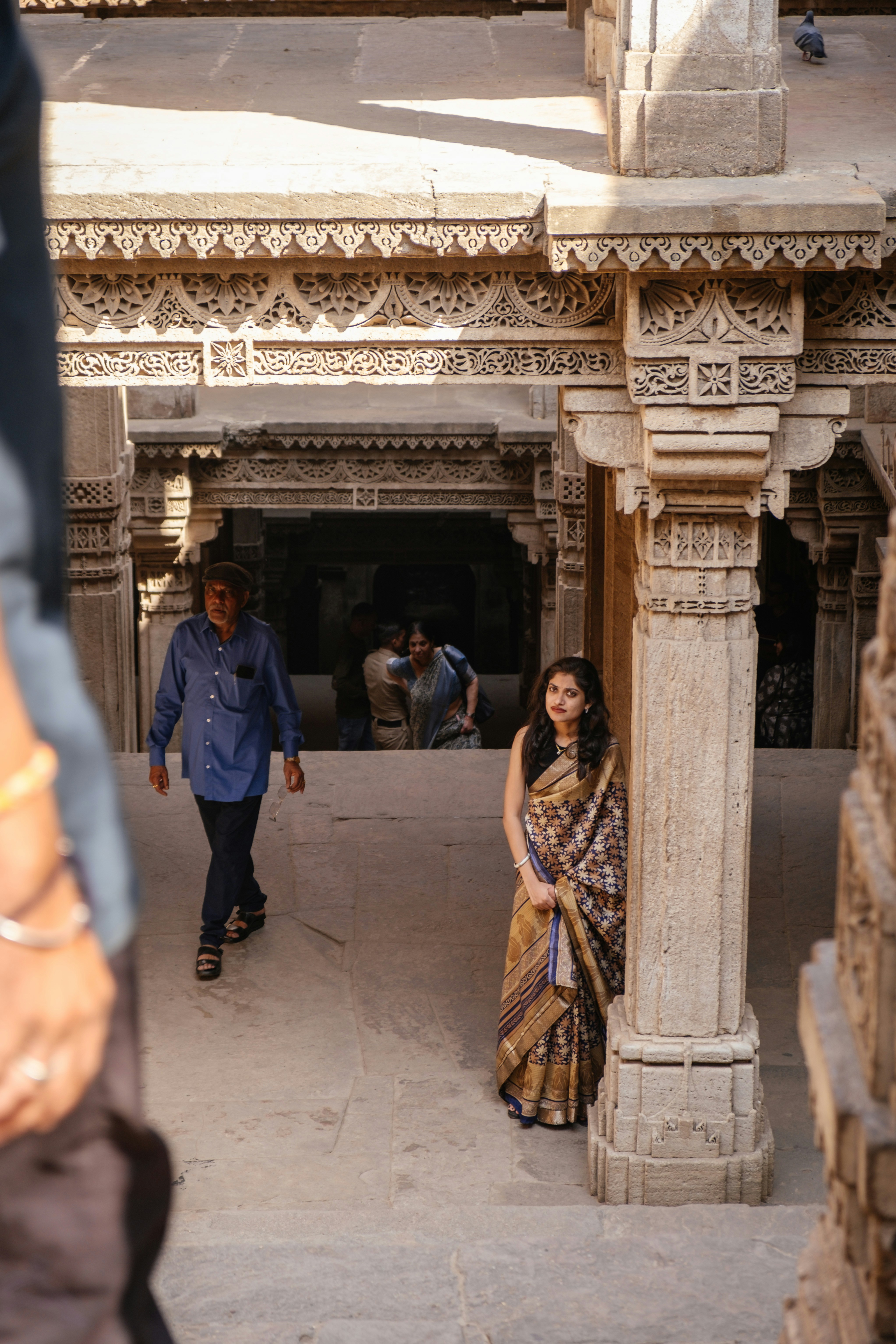 Saree Among Stone Carvings: A Quiet Moment in the Temple Courtyard