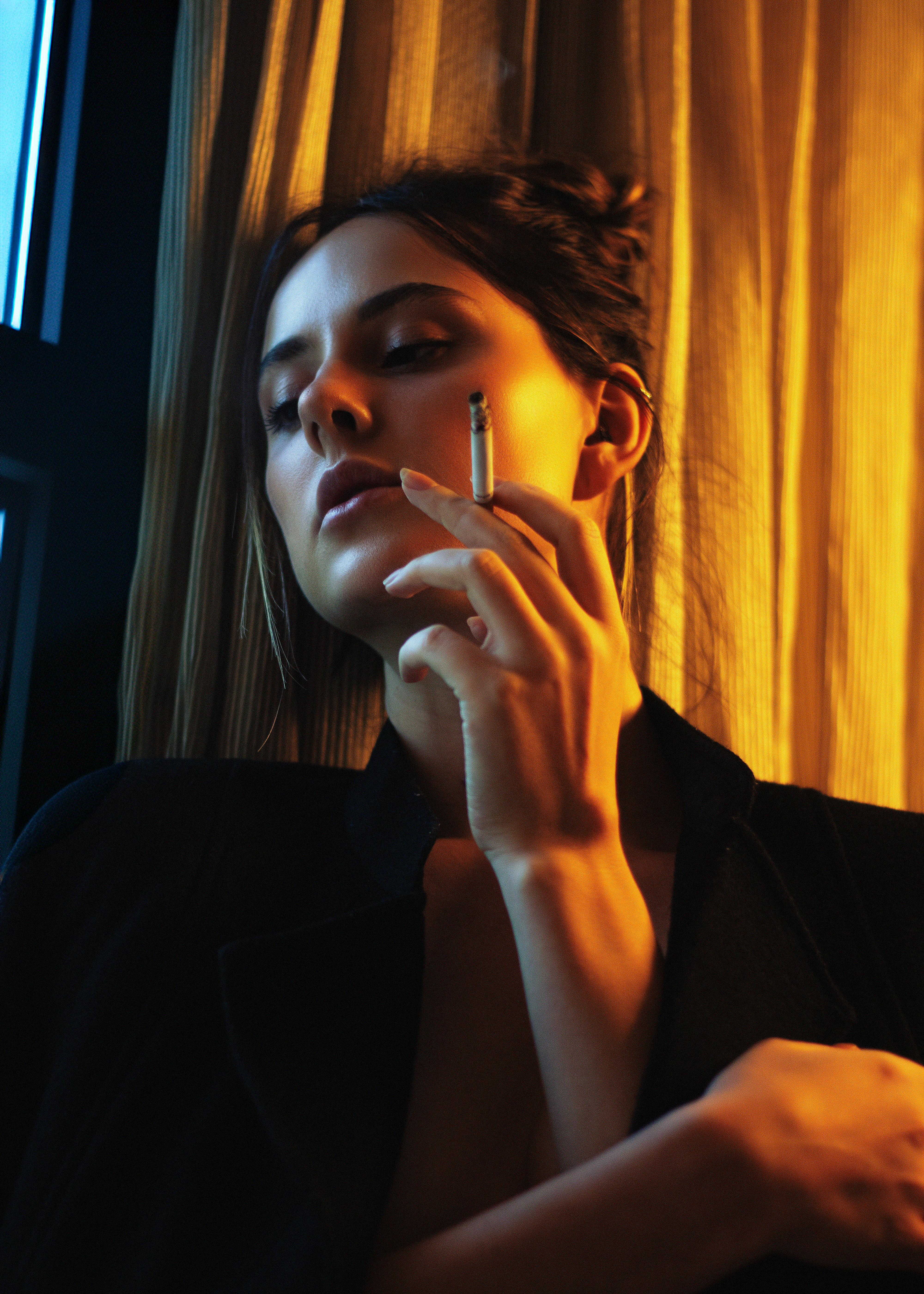 A woman smoking a cigarette in front of a window photo – Free Smoking ...