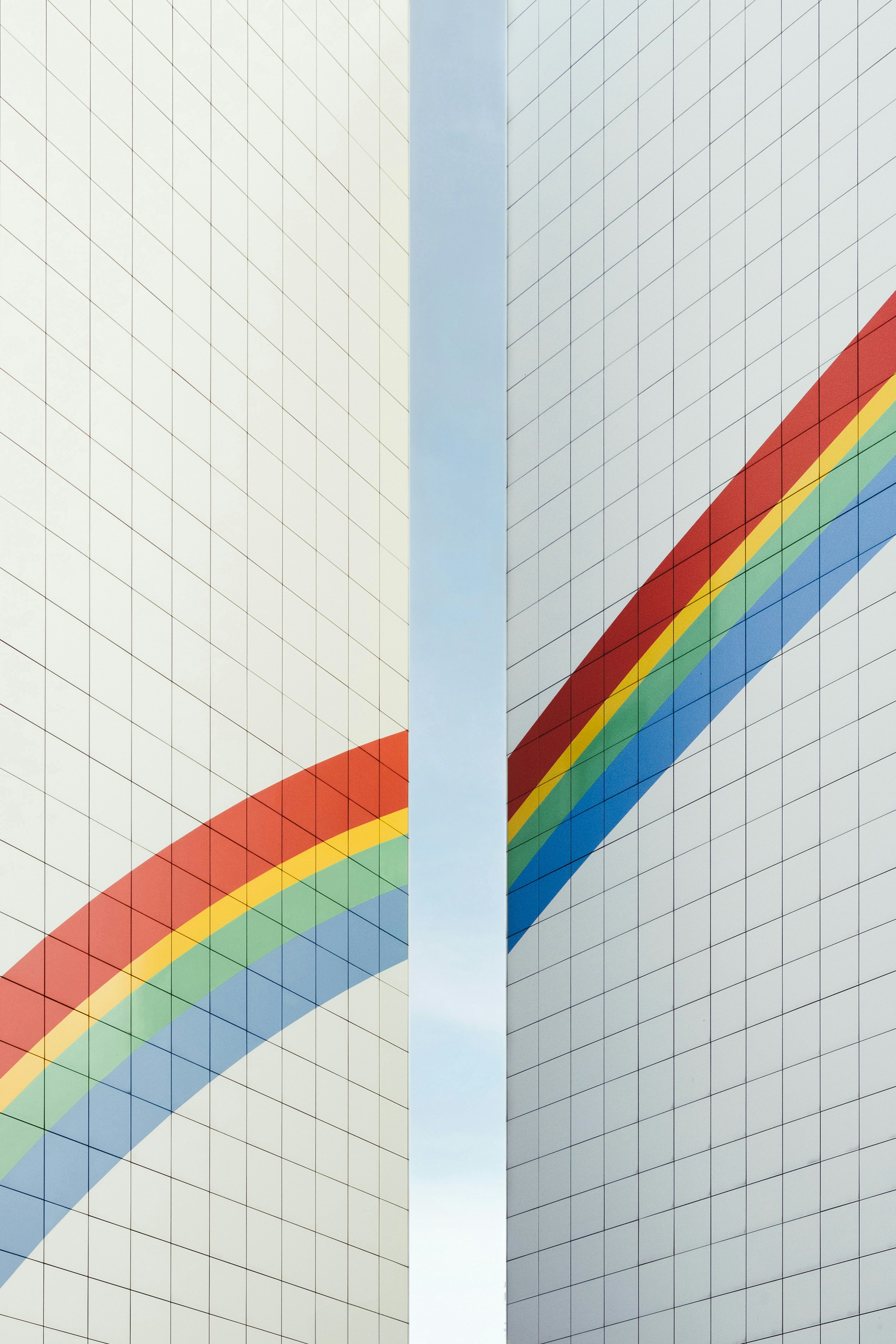 A couple of tall buildings with a rainbow painted on them photo – Free ...