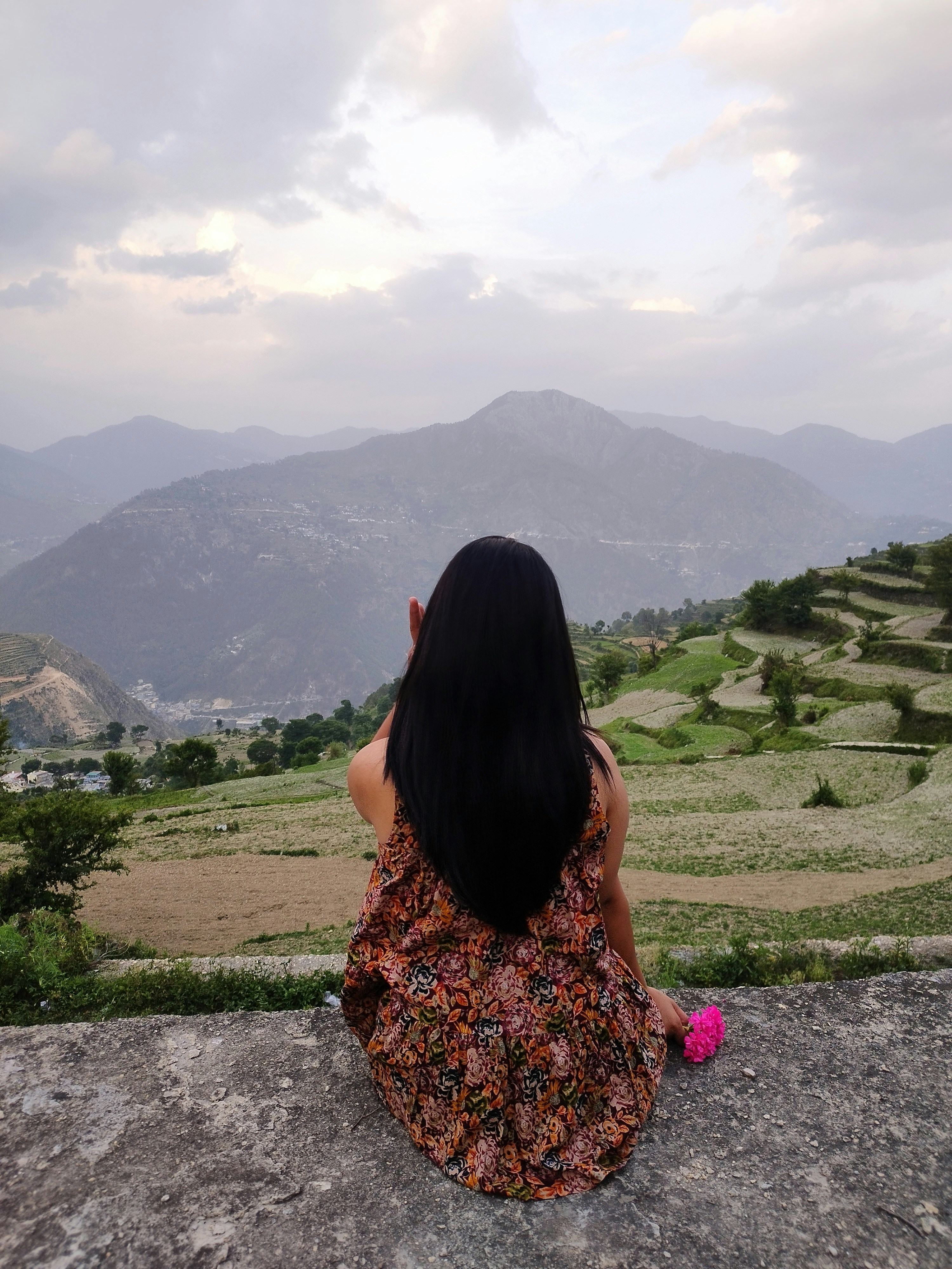 Terraced Horizon: A Woman in Floral Dress Overlooking Mountain Terraces