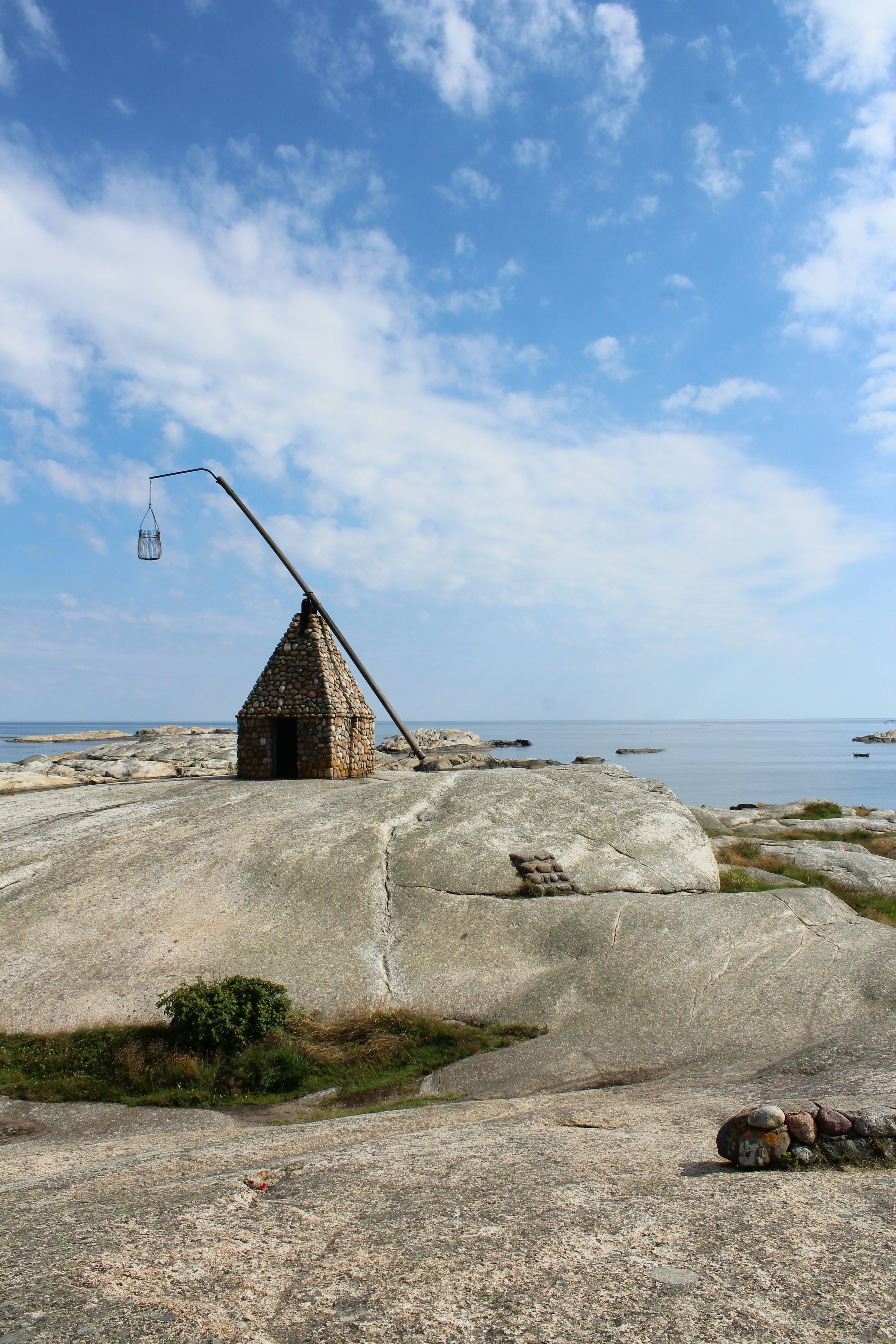 Leaning Lantern over Granite Shore: A Quiet Seaside Stone Hut