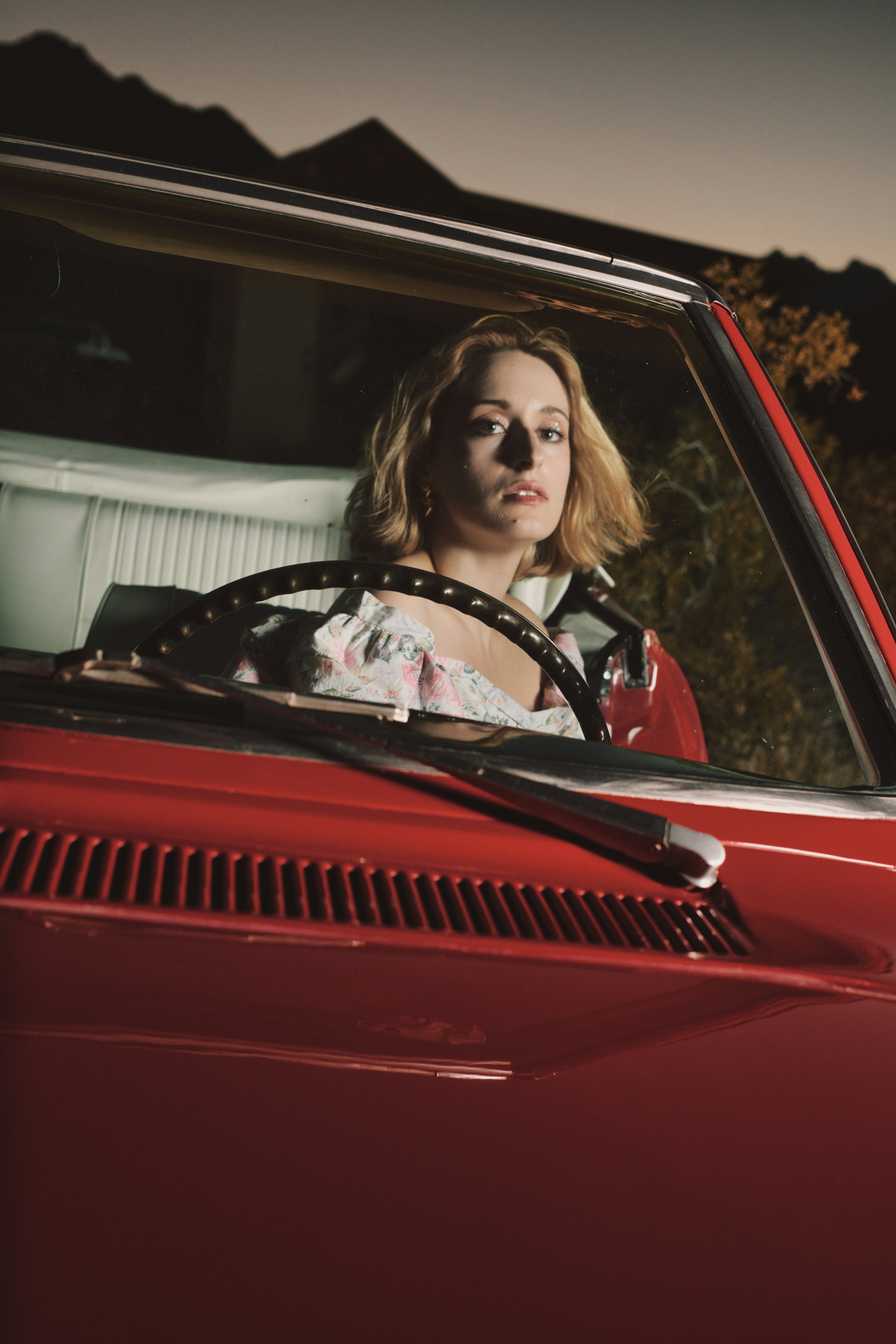Crimson Cabriolet Gaze: Portrait Through the Windshield at Twilight