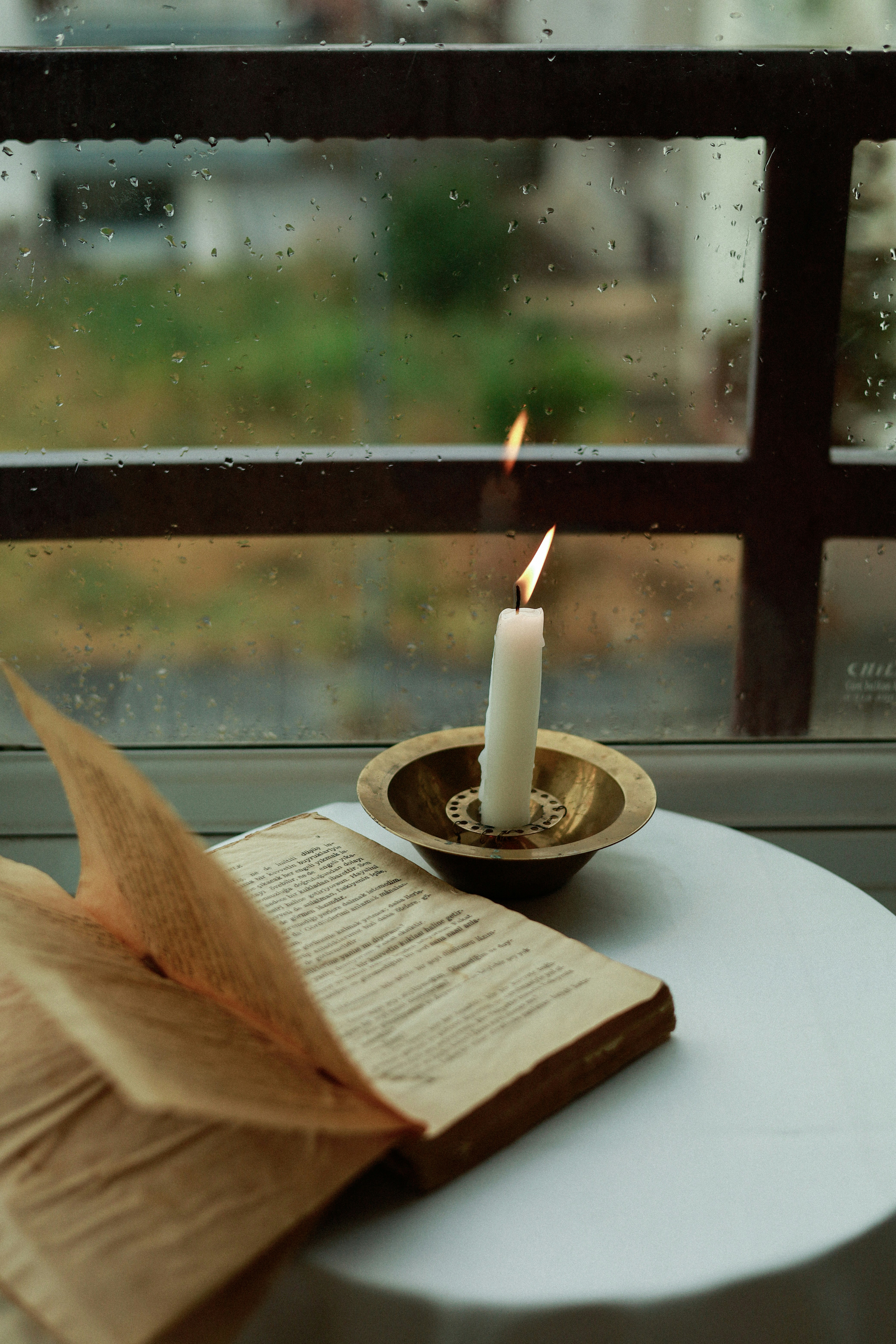An open book and a candle on a table photo – Free Candle Image on Unsplash