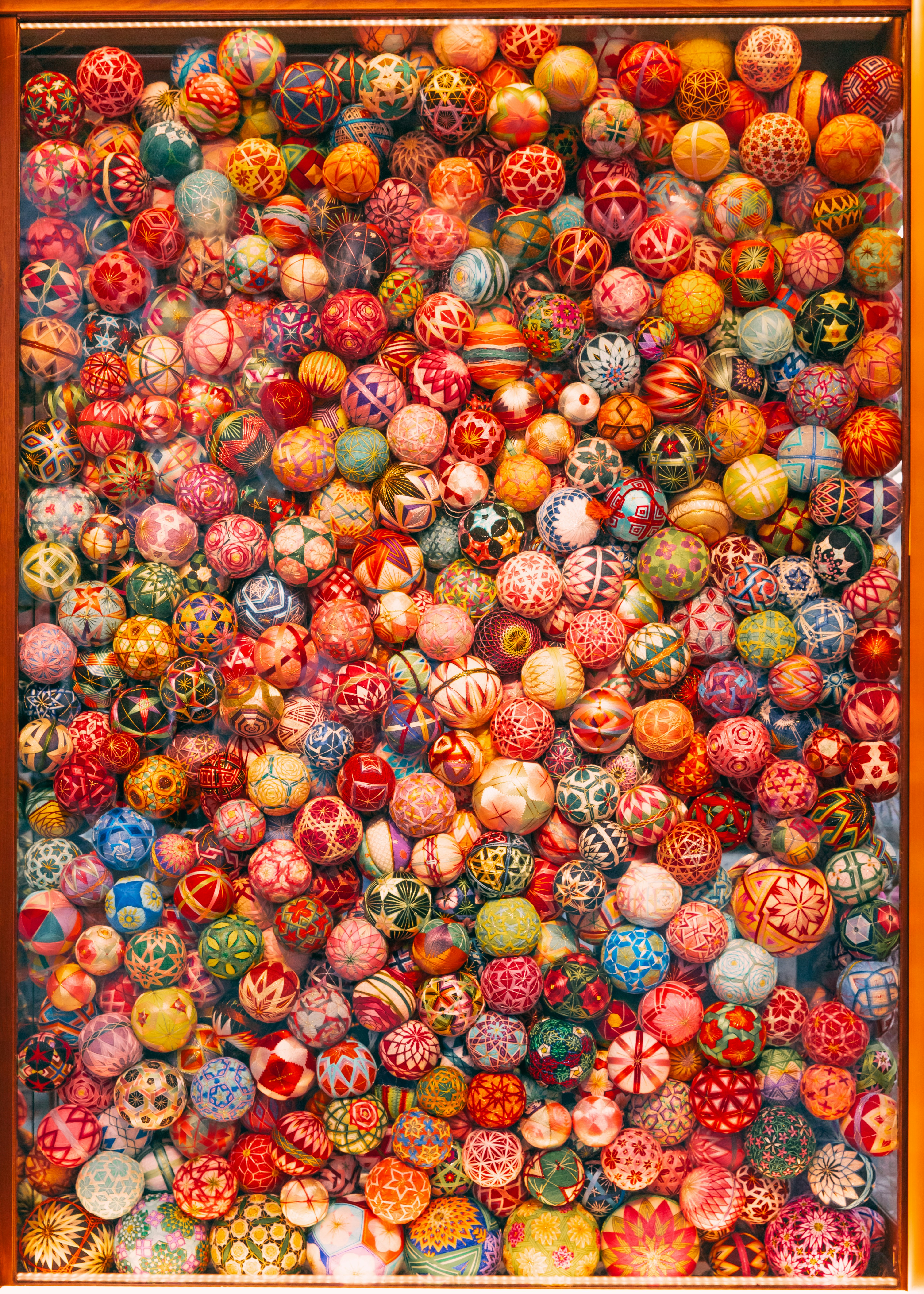 Geometric Kaleidoscope: A Glass Cabinet of Temari Balls