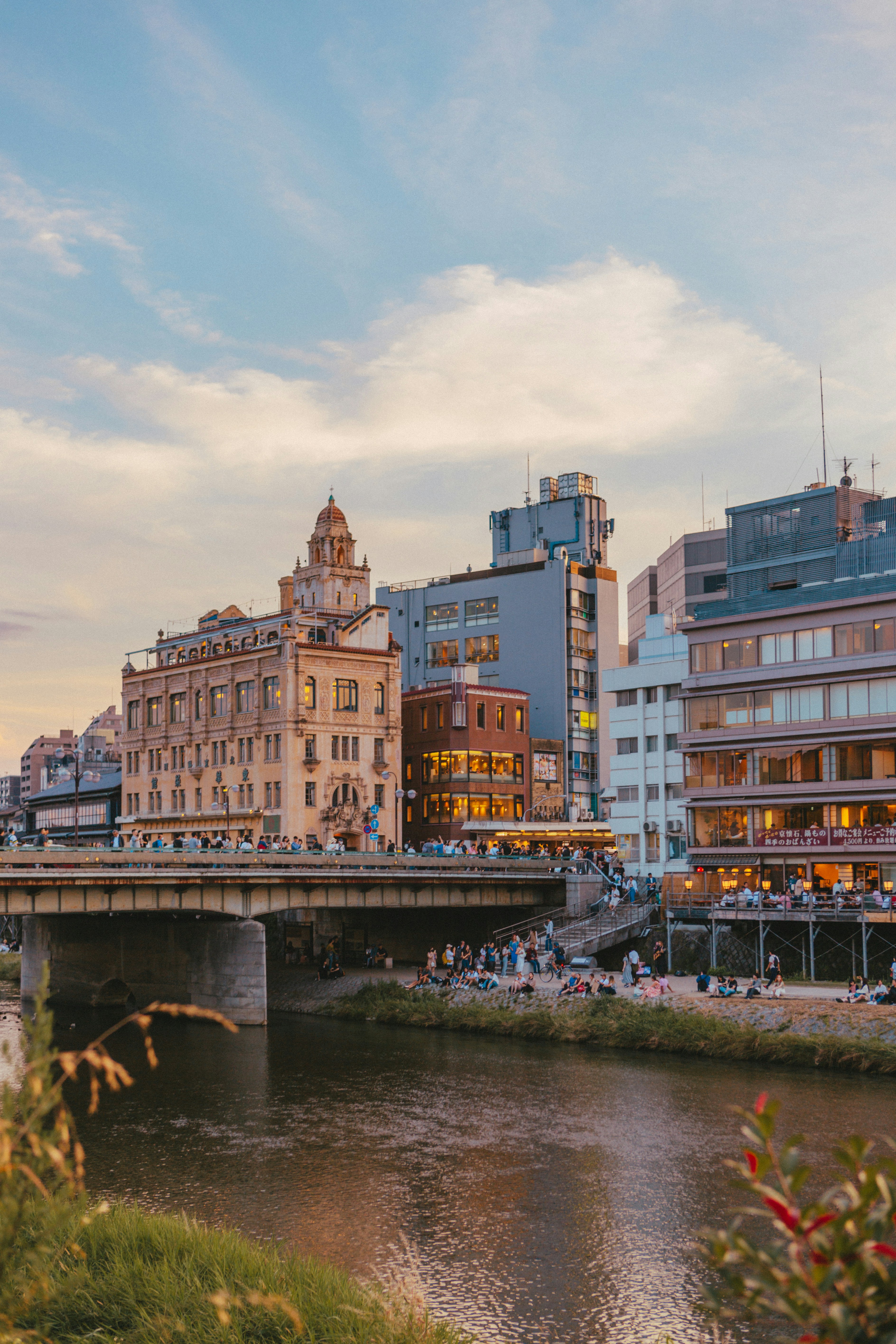 Dusk over the Riverside Quarter: Historic Facades and a Busy Bridge