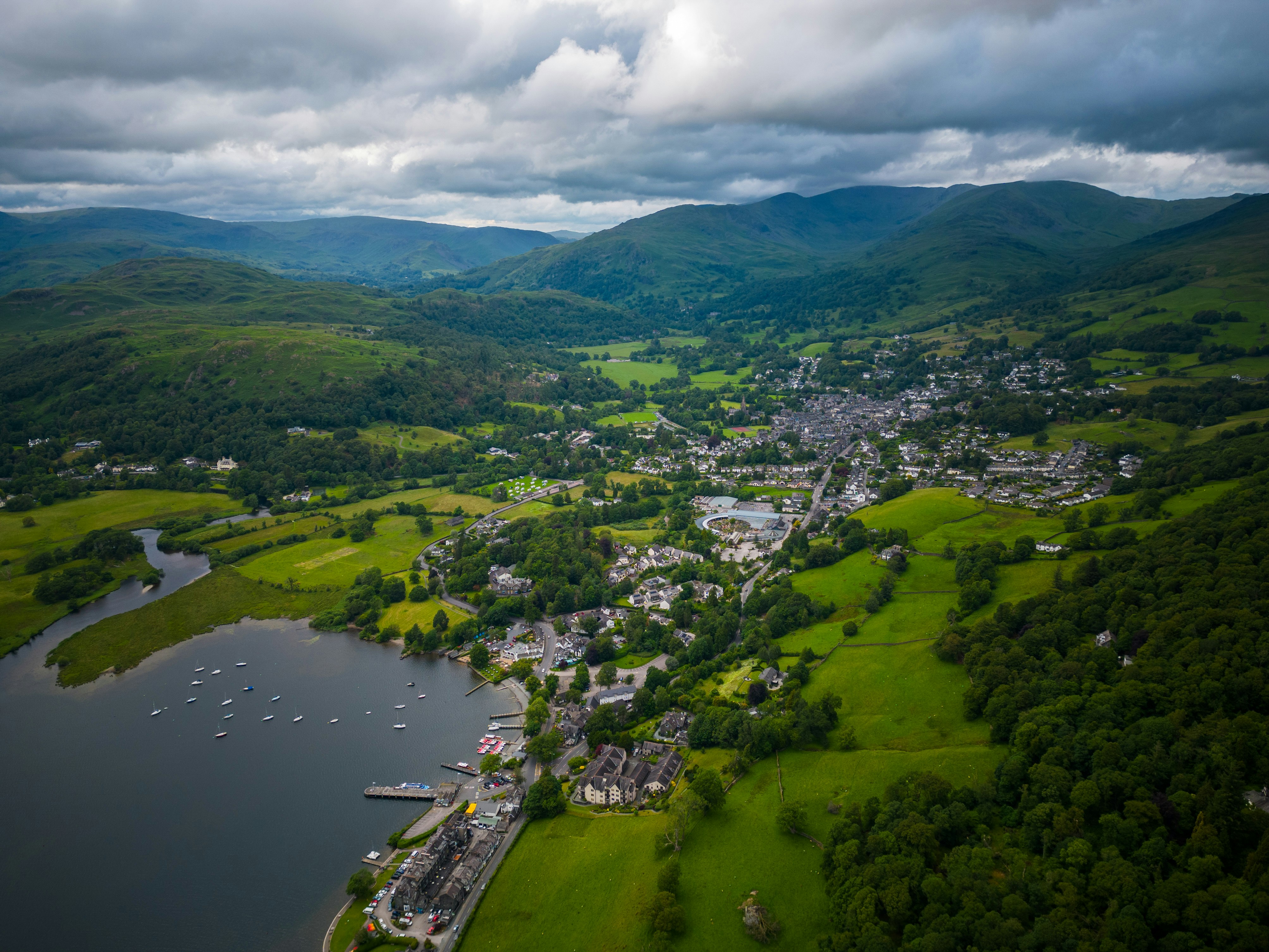 Verdant Valley Vista: Lakeside Village Framed by Rolling Hills