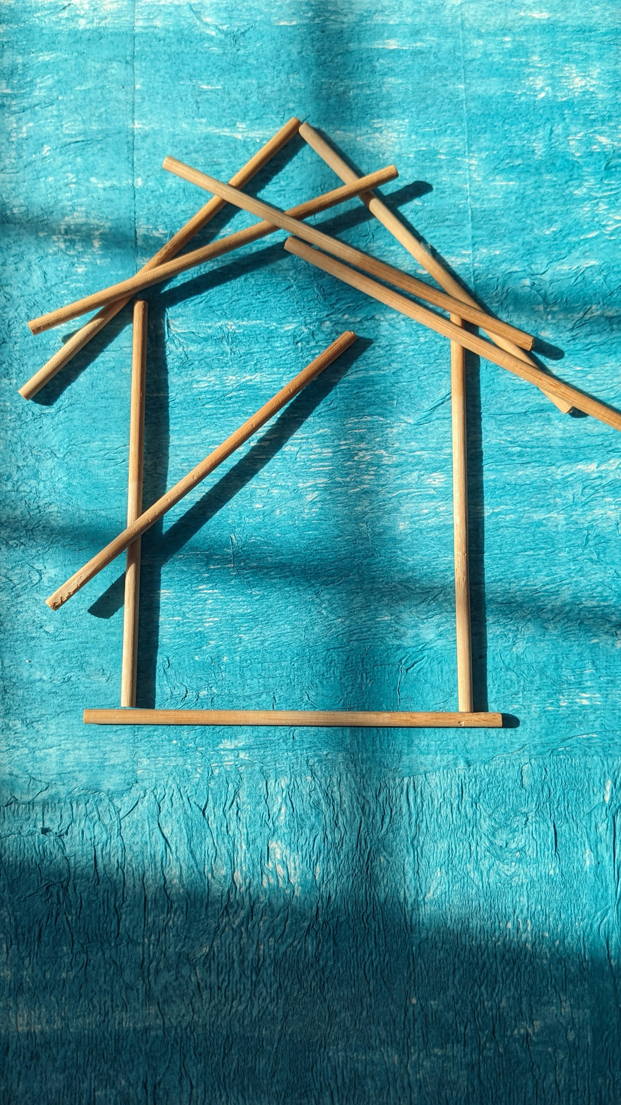 A house made out of sticks on a blue surface photo – Free Art Image on ...