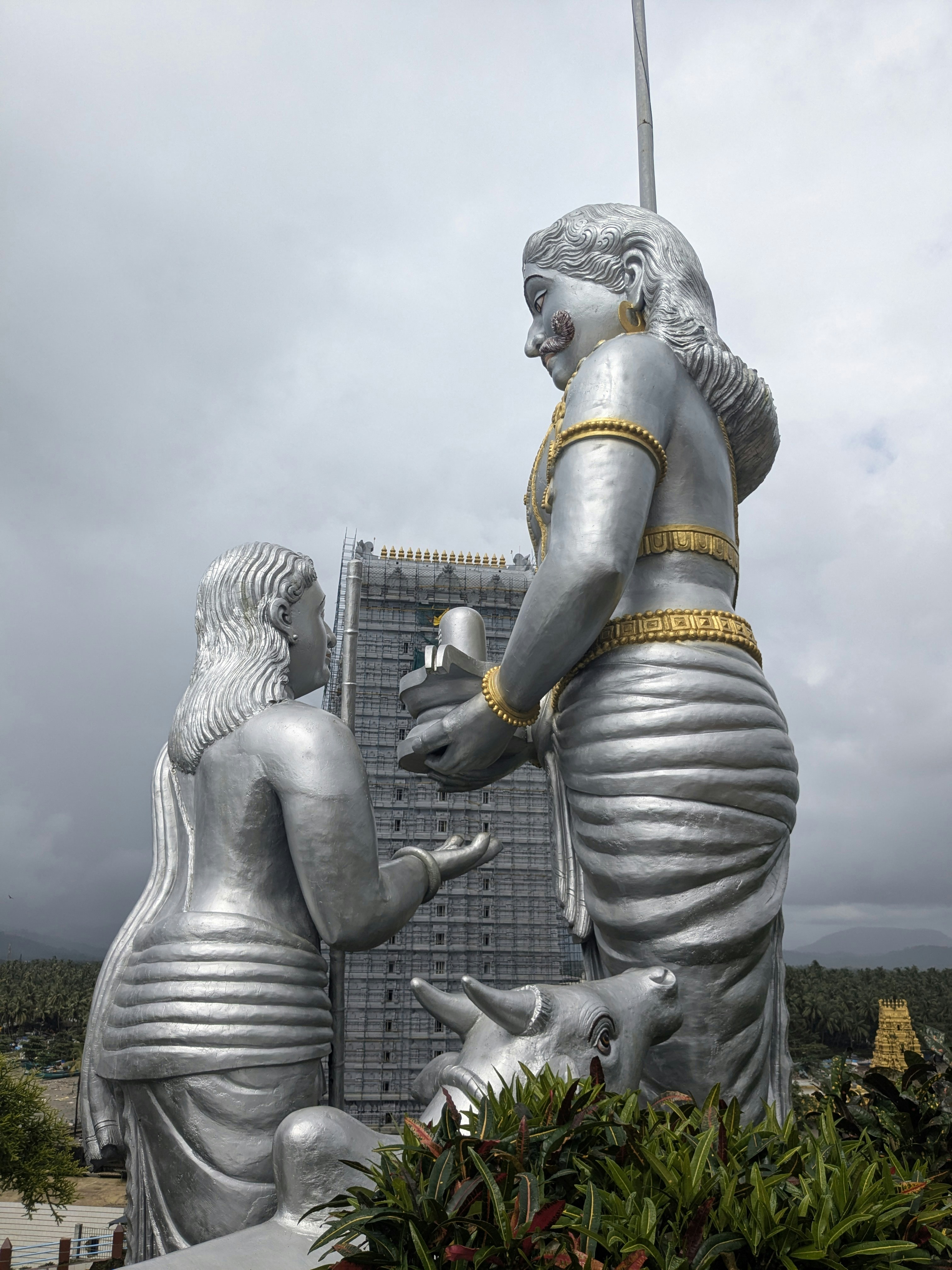 Giant Silver Deities: A Sacred Conversation Under Clouded Skies