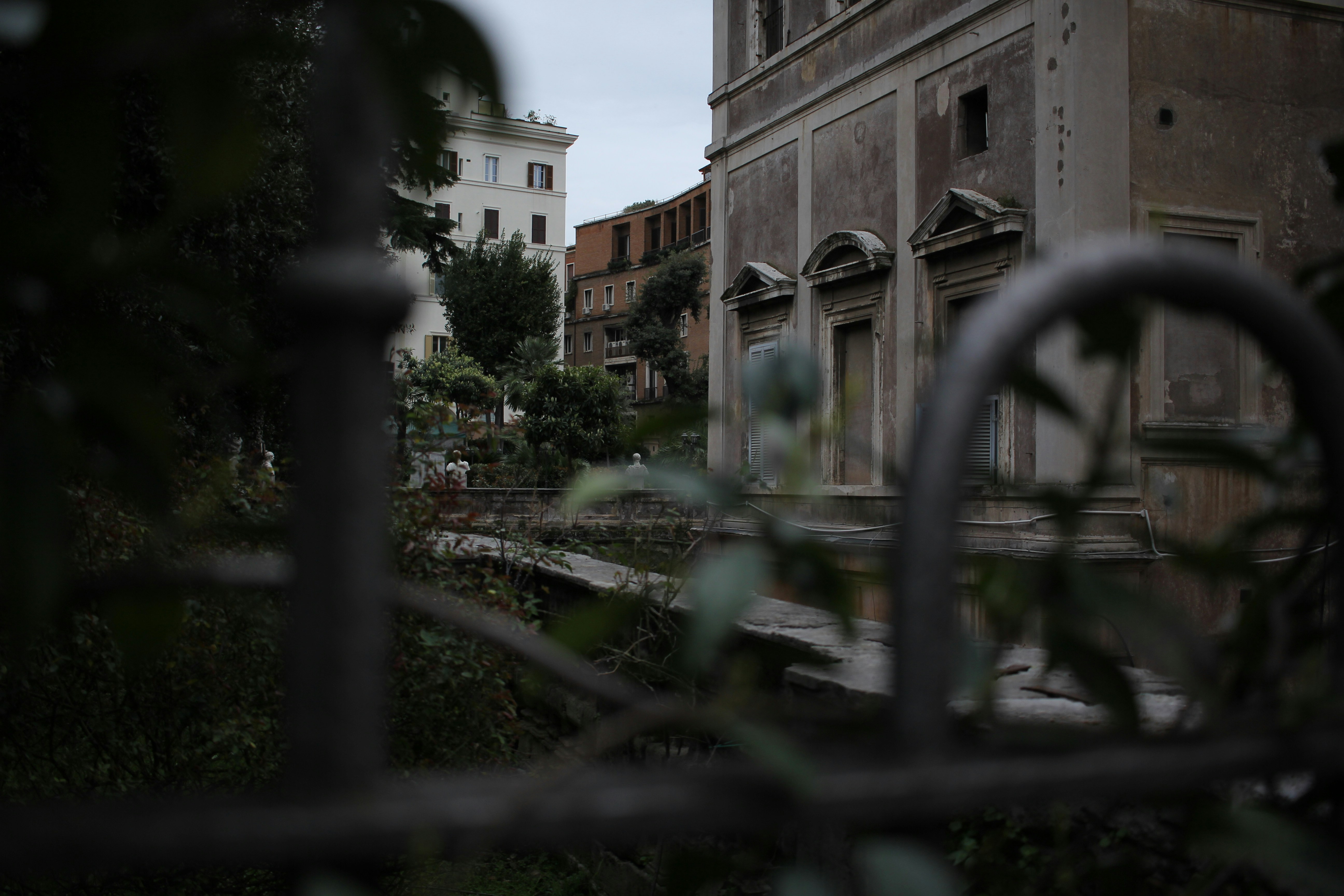 Veiled Architecture: A Quiet Courtyard Beyond Ironwork
