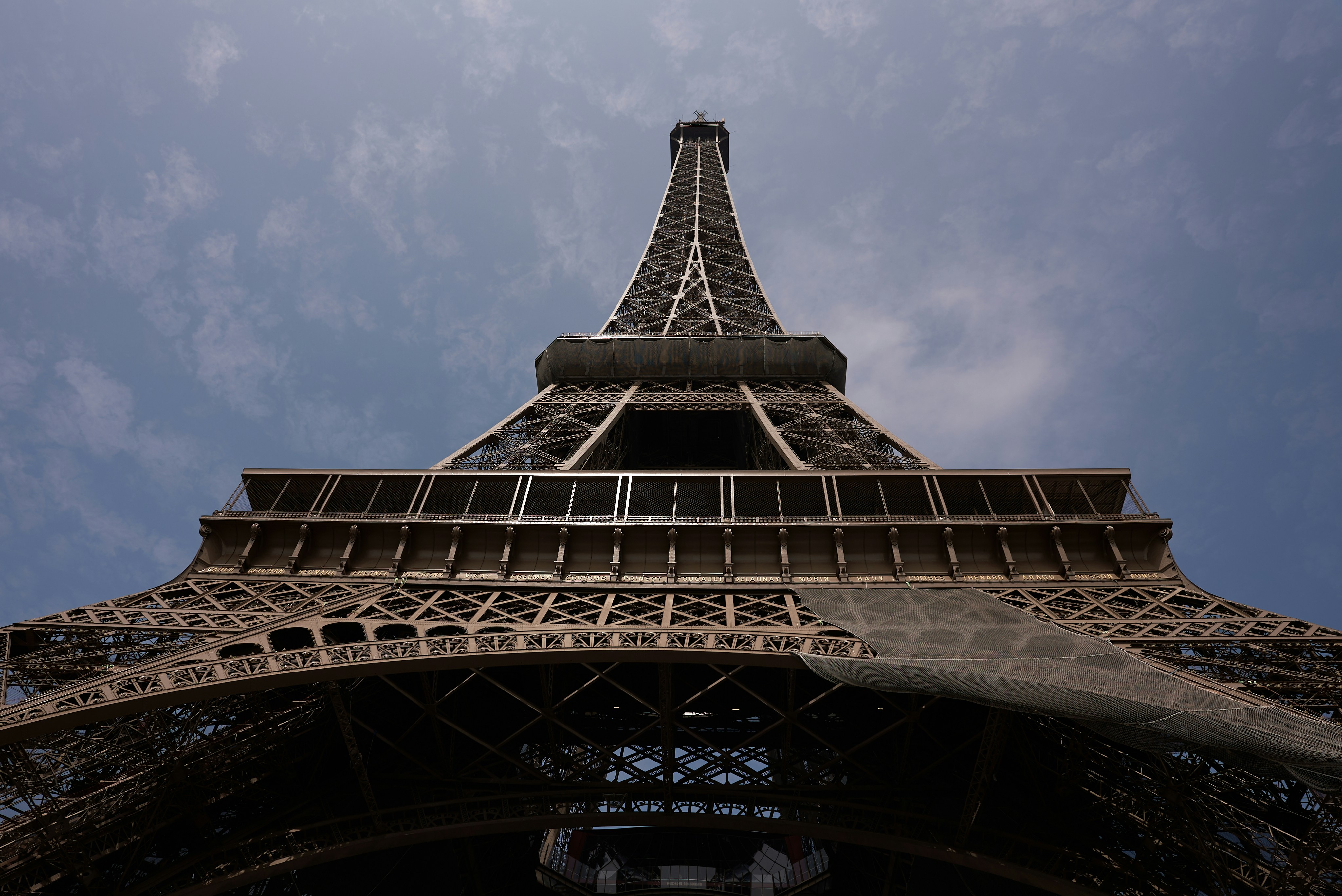 Iron Lace Reaching Skyward: Upward View of the Eiffel Tower