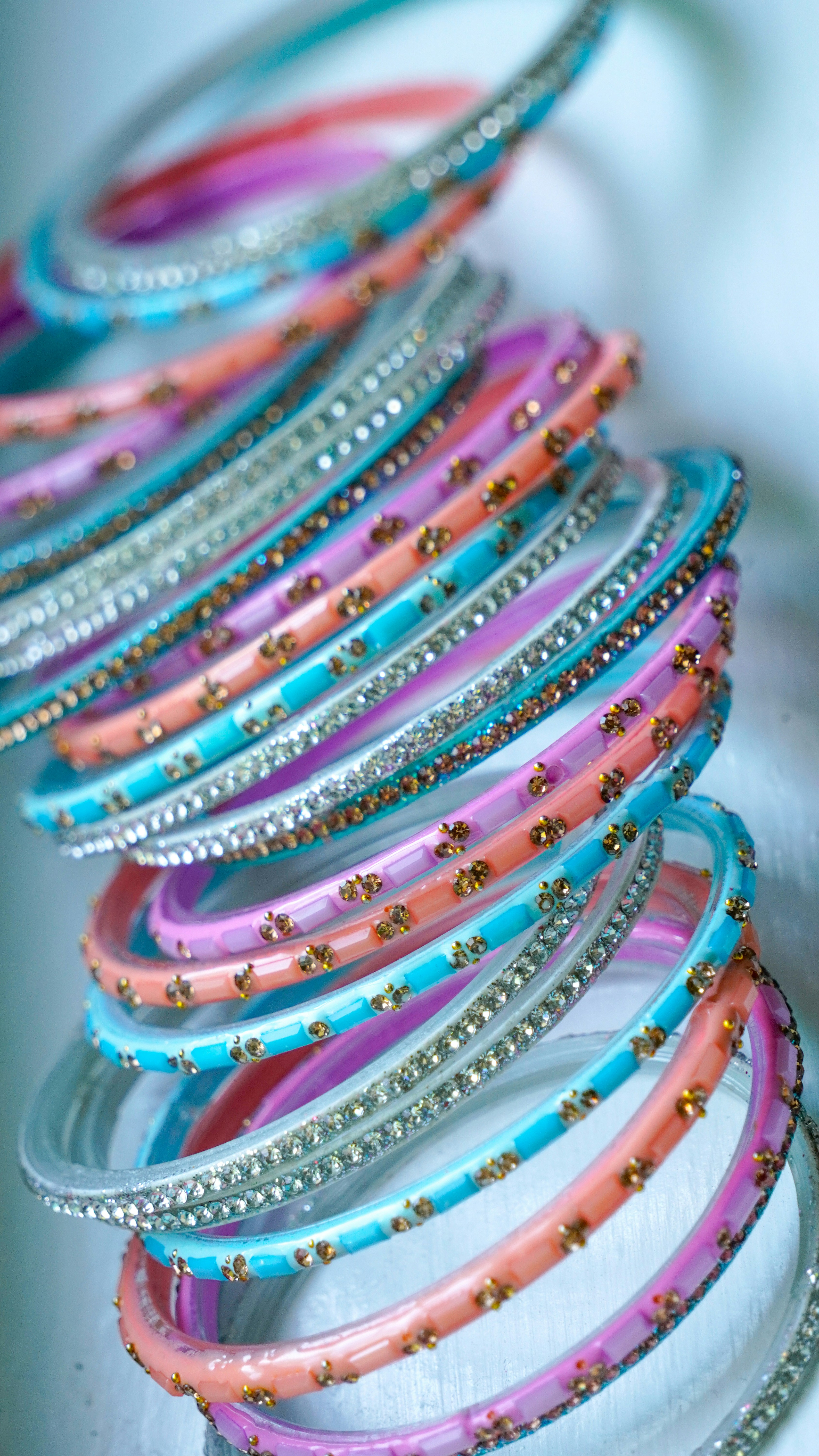 A bunch of bracelets that are on a table photo – Free Bangles Image on ...