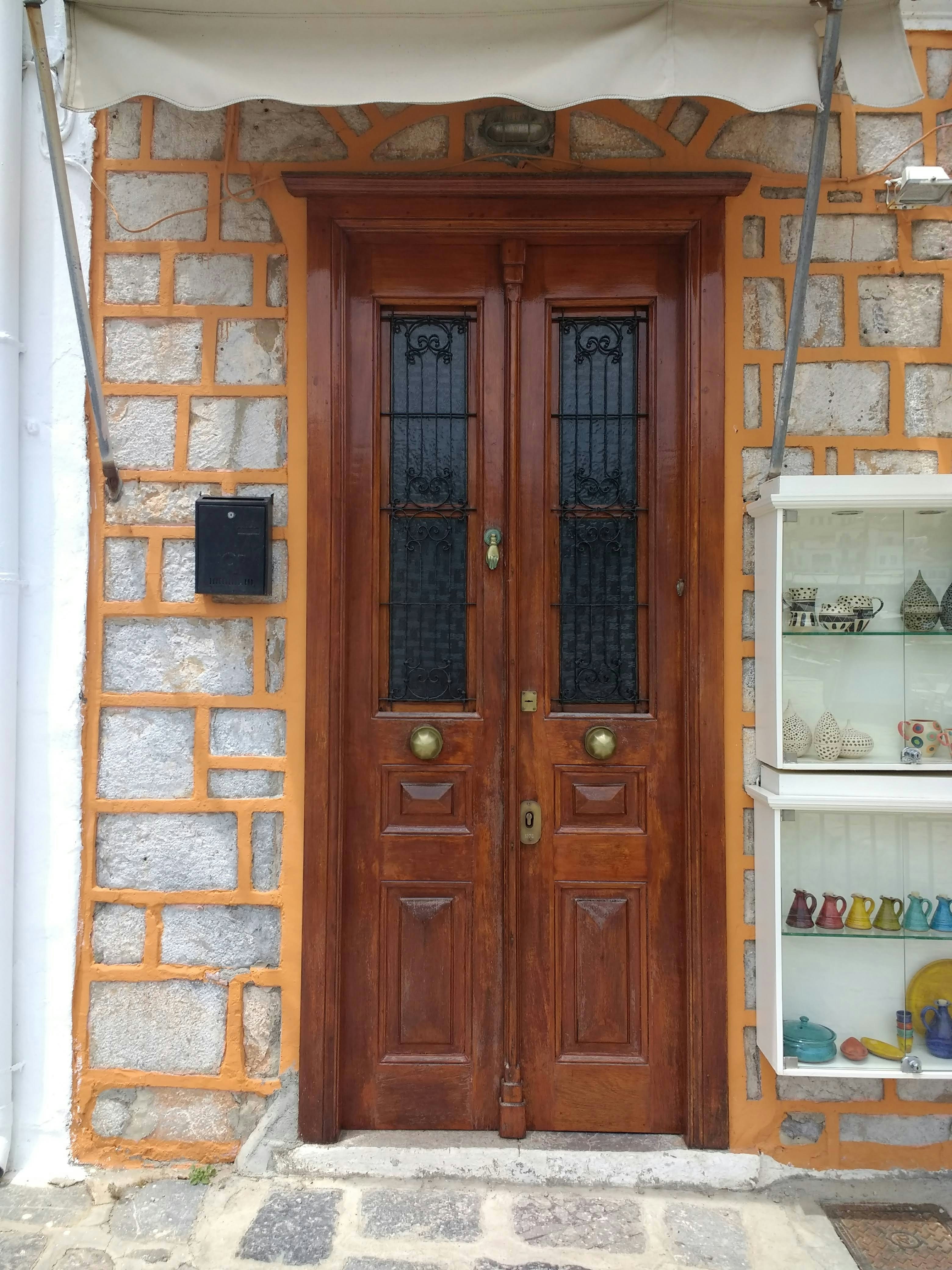 A wooden door sitting next to a brick building