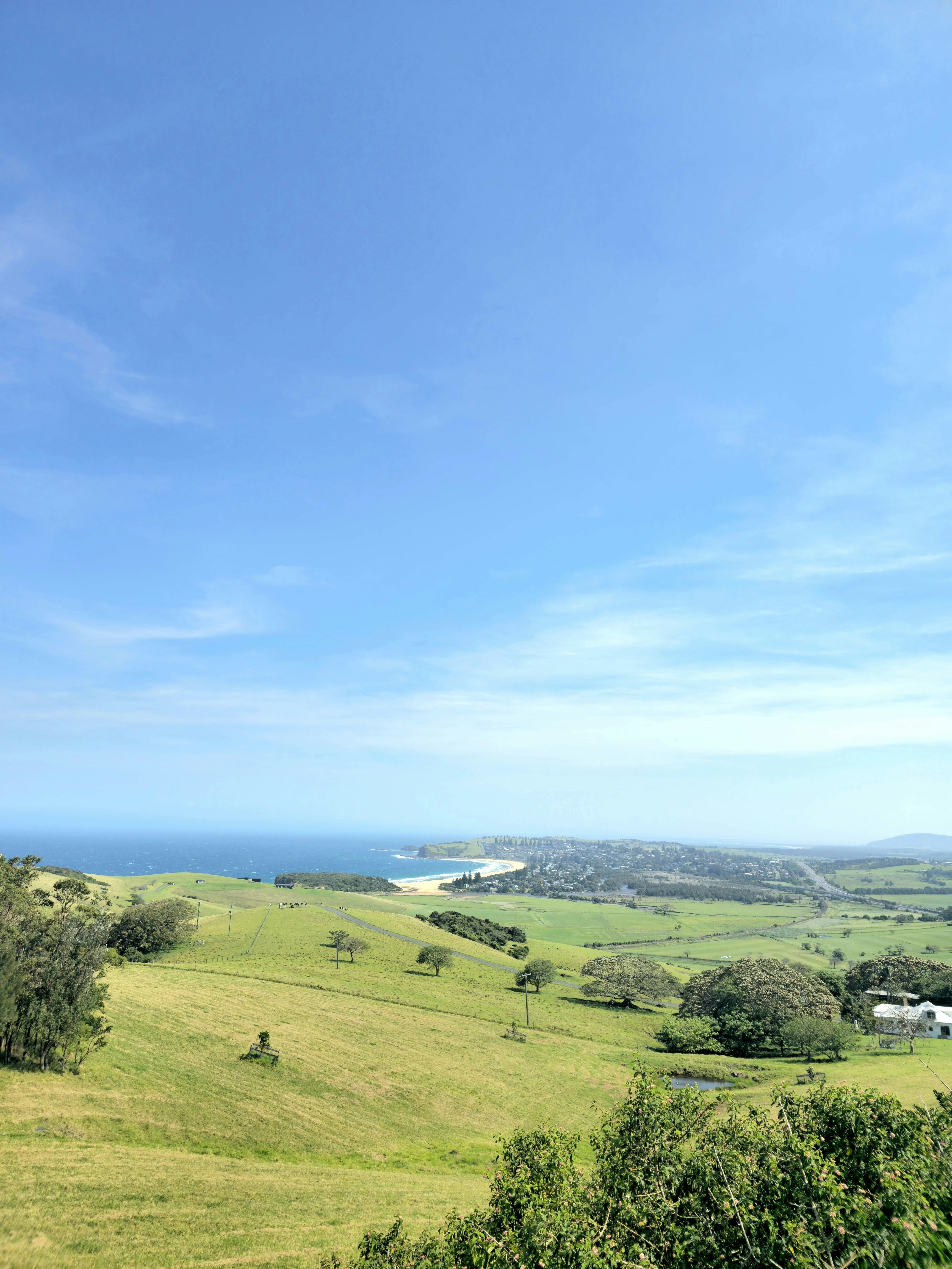Verdant Hills Meet the Distant Coast Under a Clear Atlantic Sky