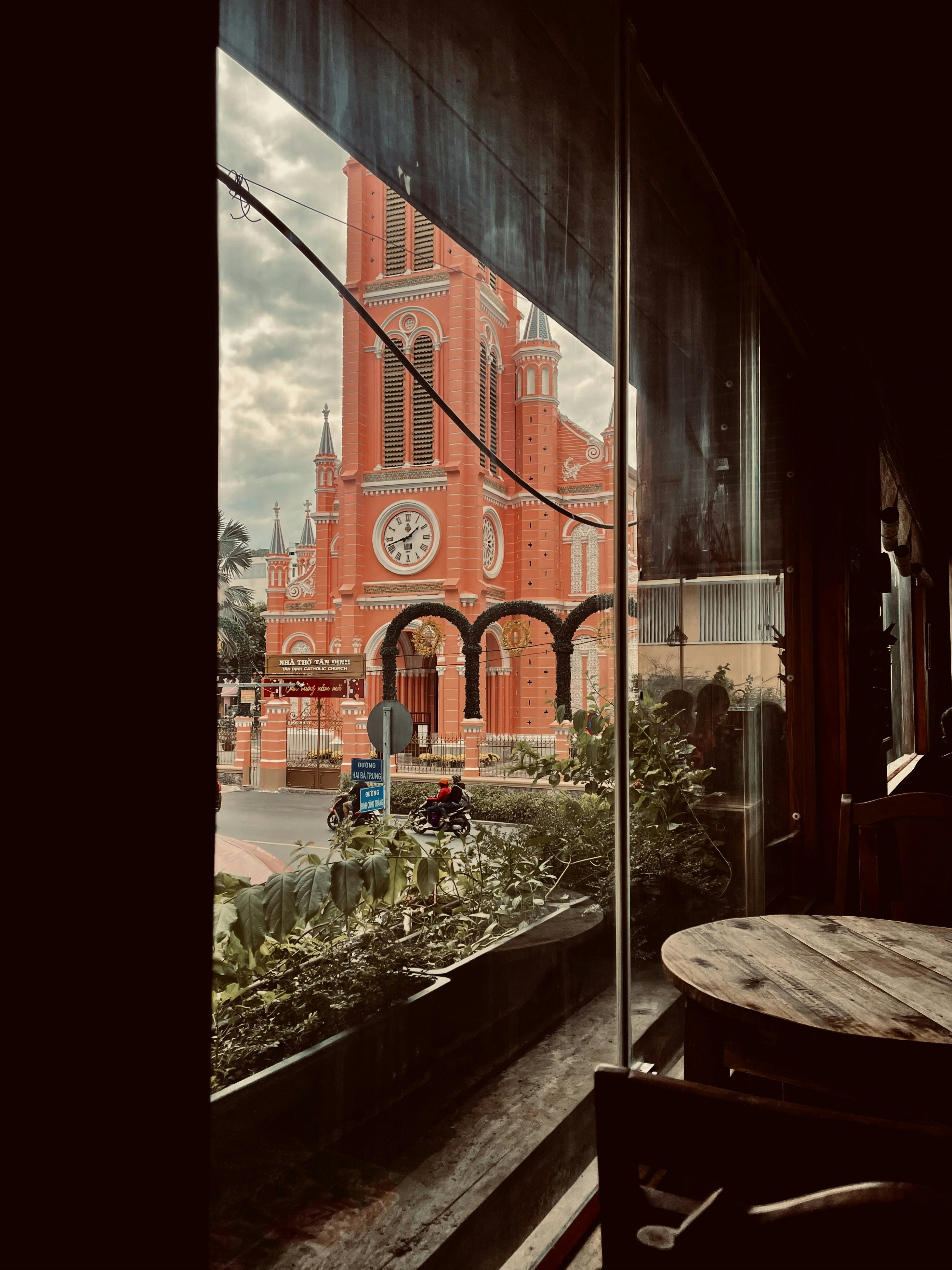 A view of a clock tower through a window photo – Free Building Image on ...