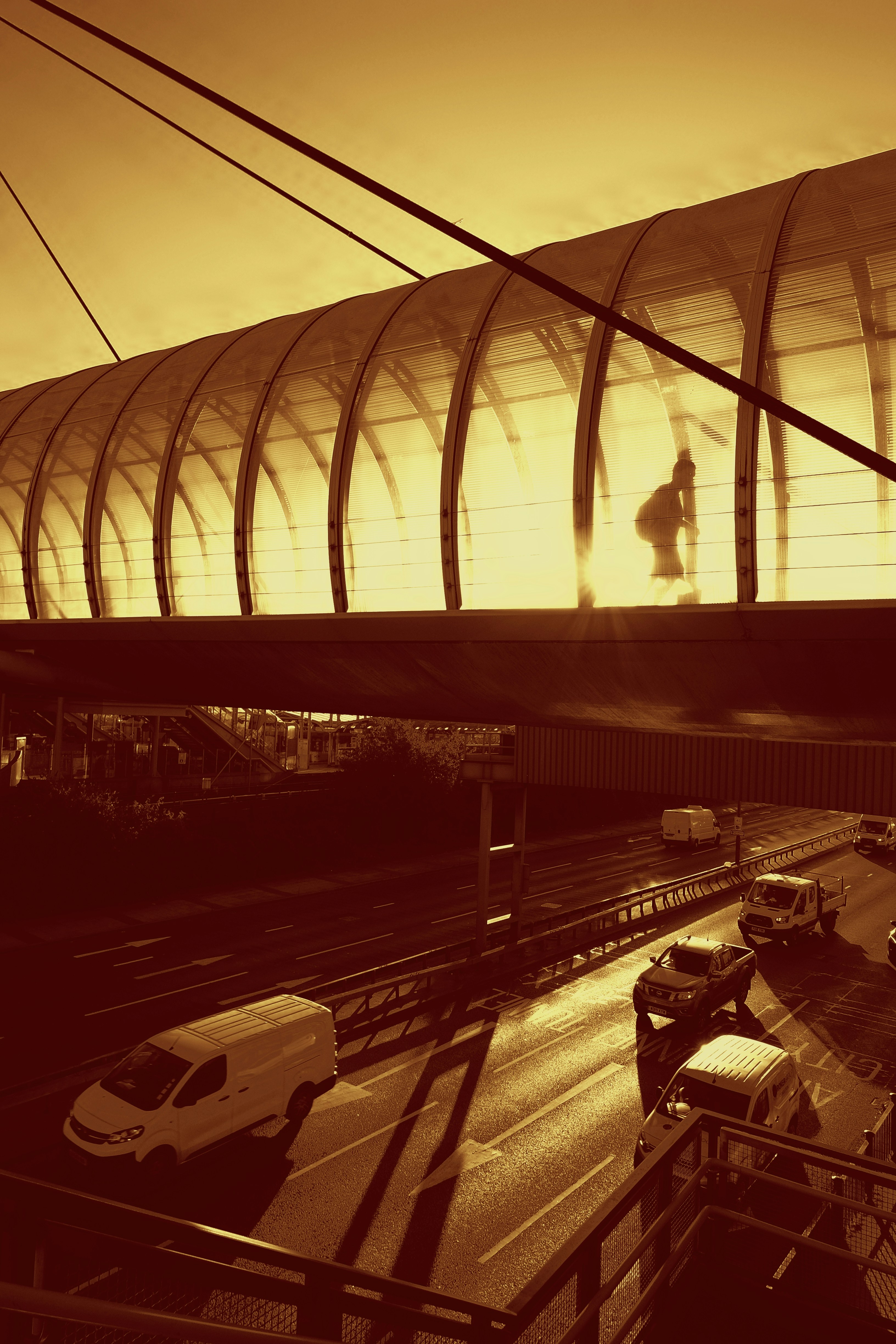 A person walking across a bridge over a street photo – Free Poplar ...