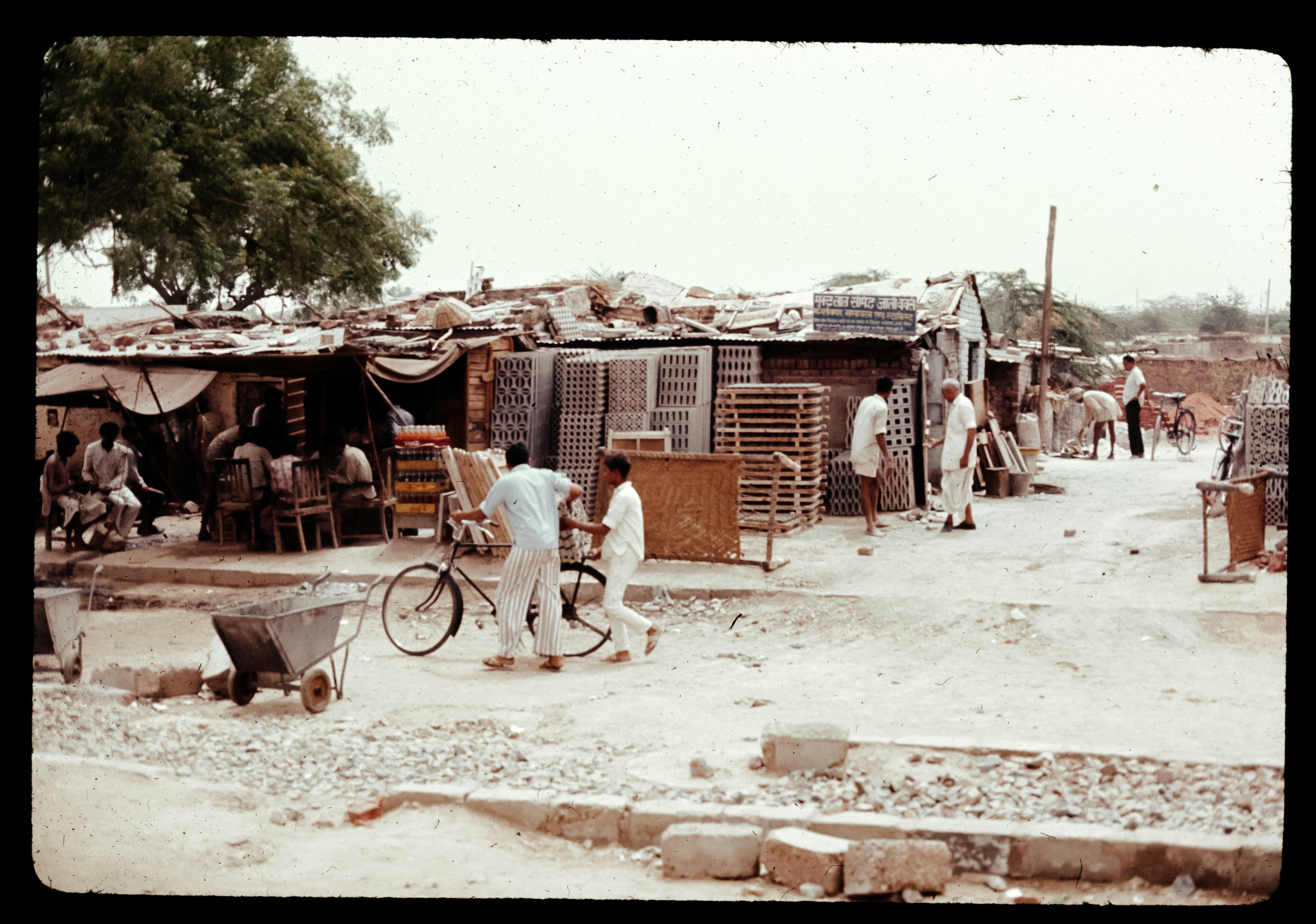 A group of people standing around a shack photo – Free Man Image on ...