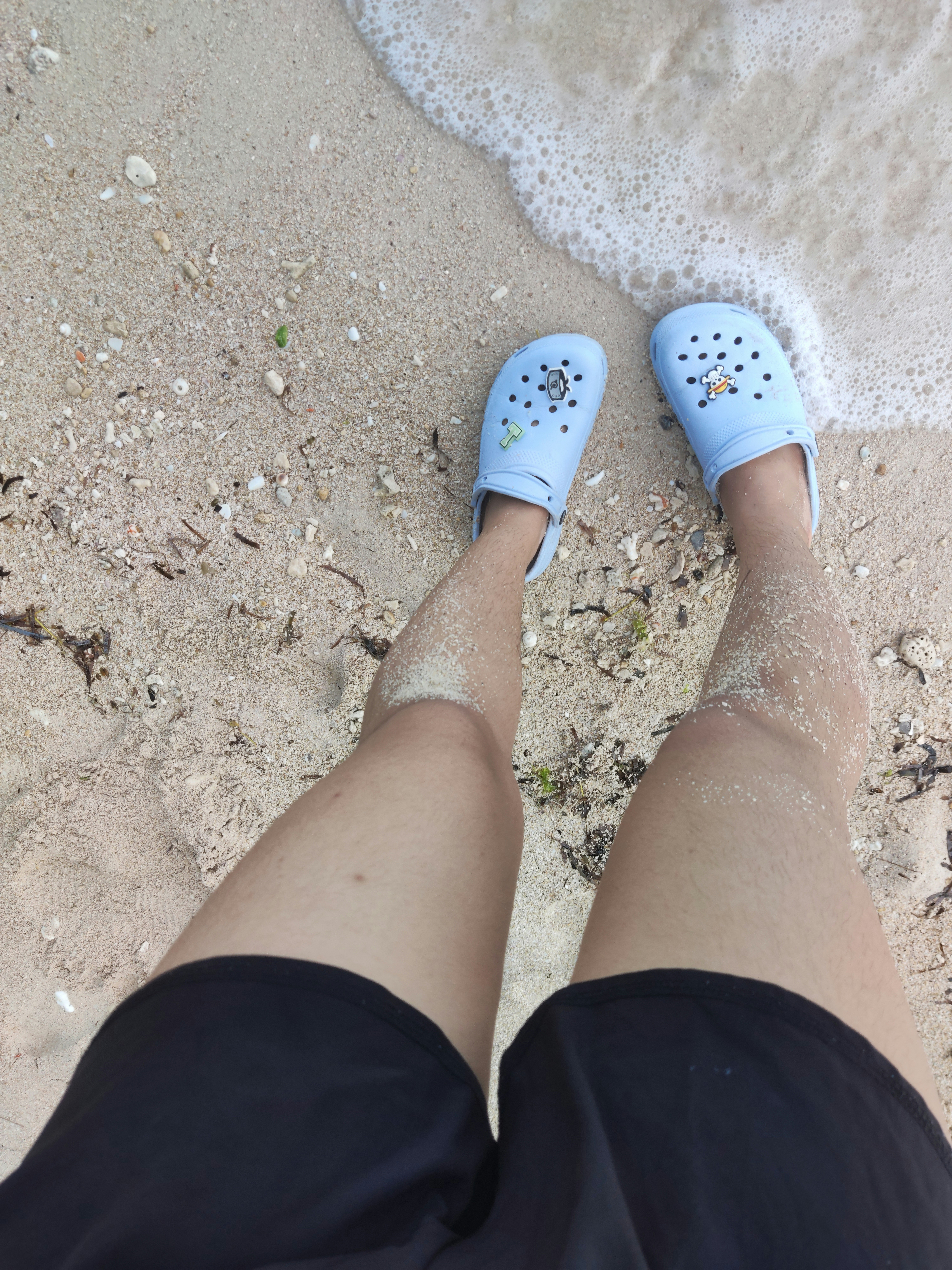Blue Crocs at the Tidal Edge: Footwear on Wet Sand