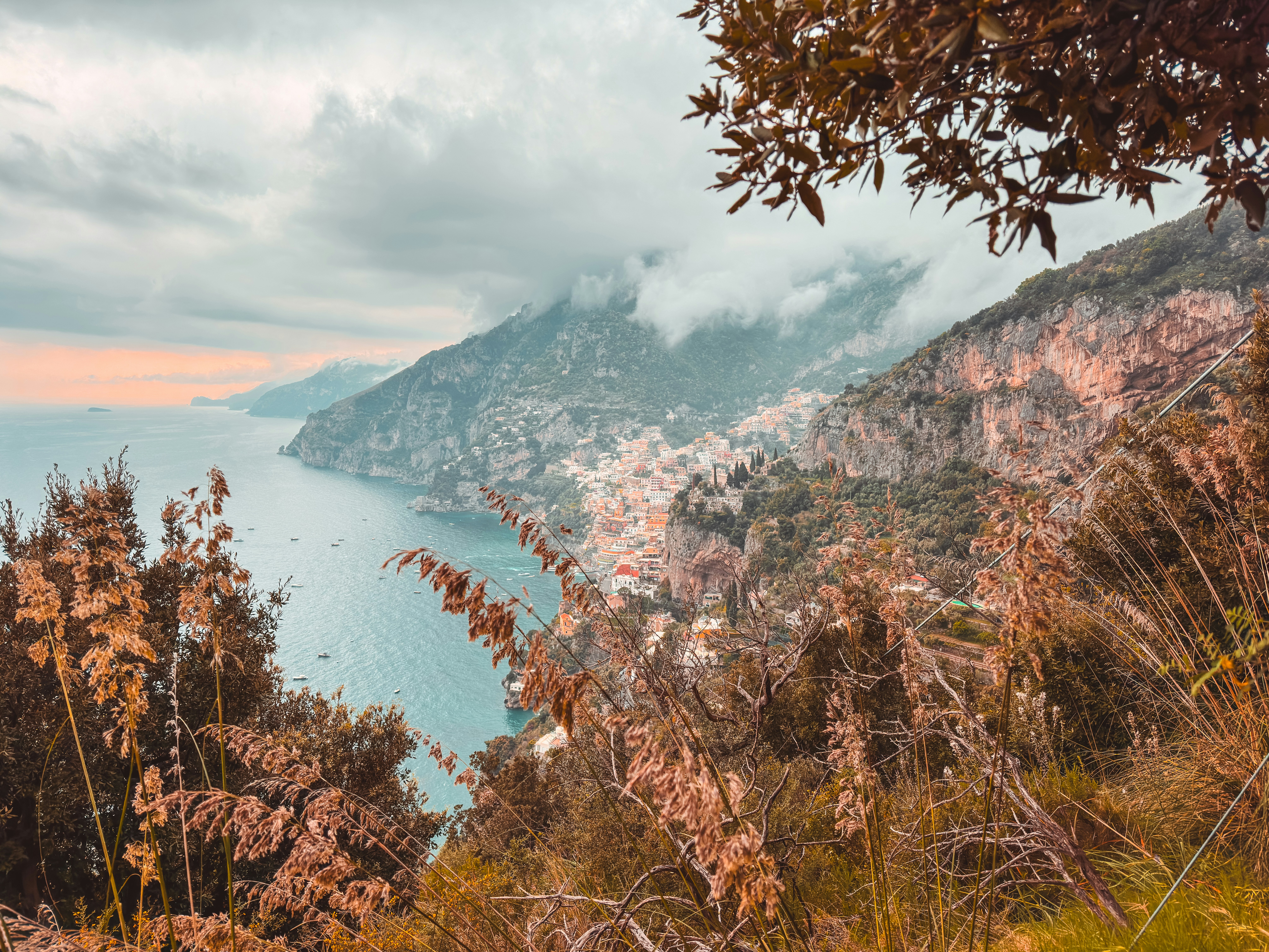 Terracotta Coastline: Cliffs, Sea, and a Quiet Village in Autumn Light