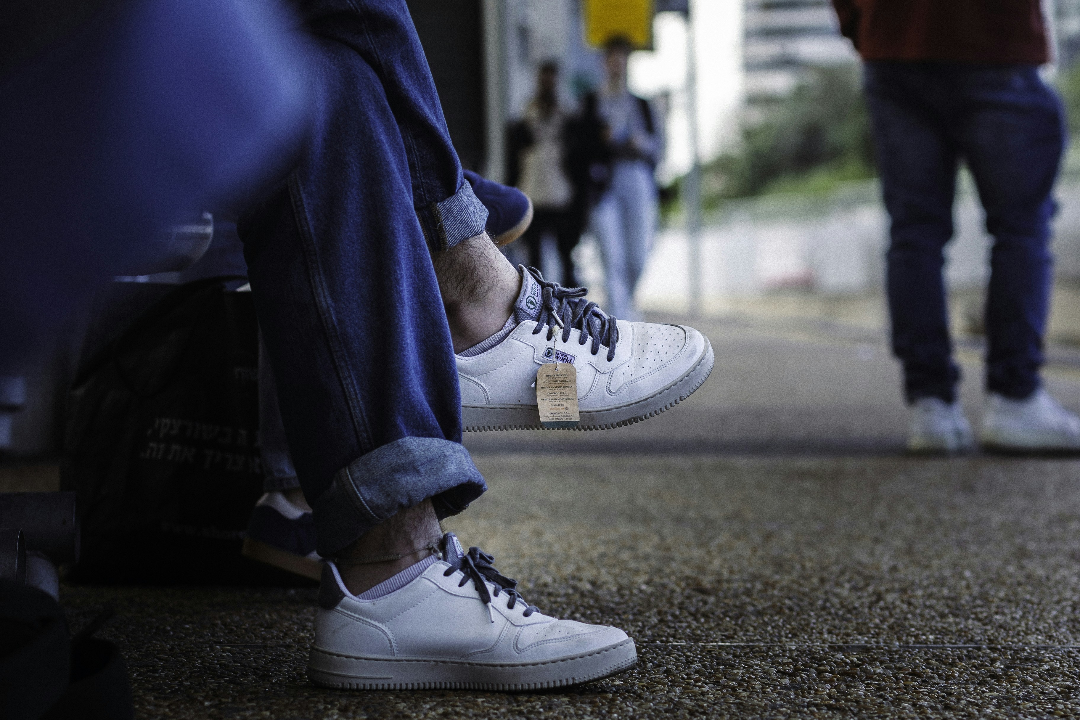 Tag on White Kicks Grounds a Quiet Moment Amid Urban Flow