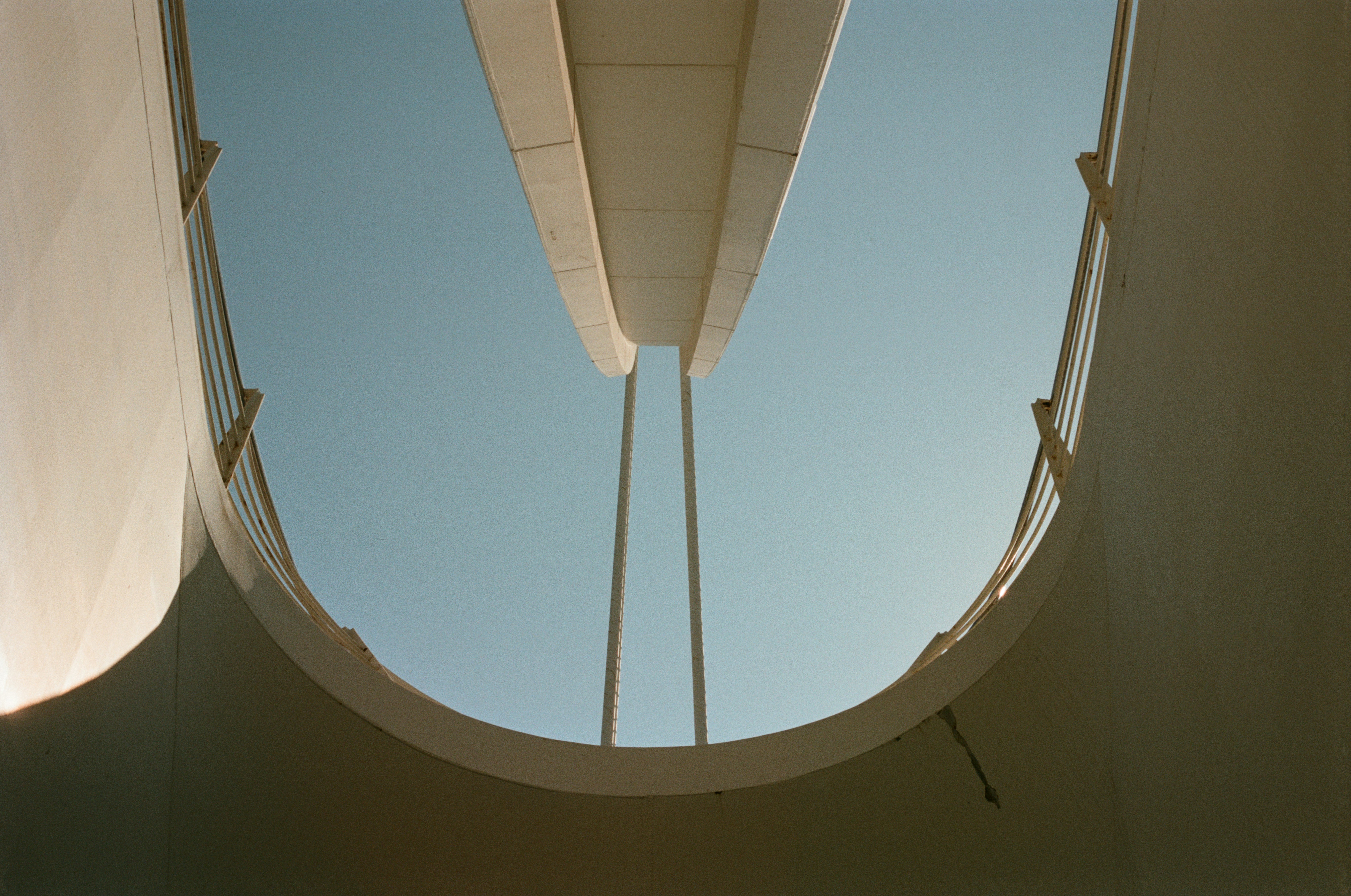 A view of a building through a circular window photo – Free Geometry ...