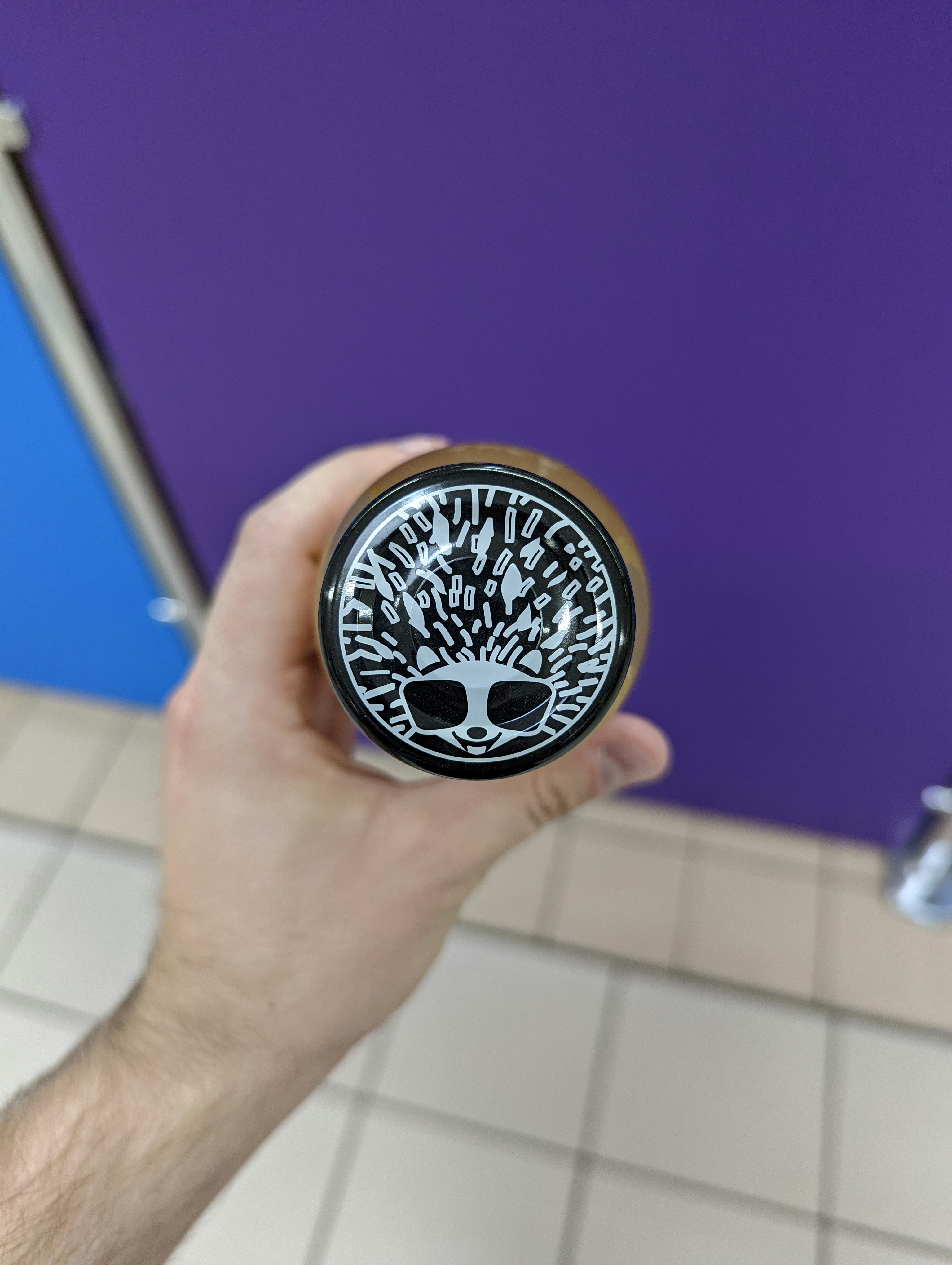A person holding a round object in their hand