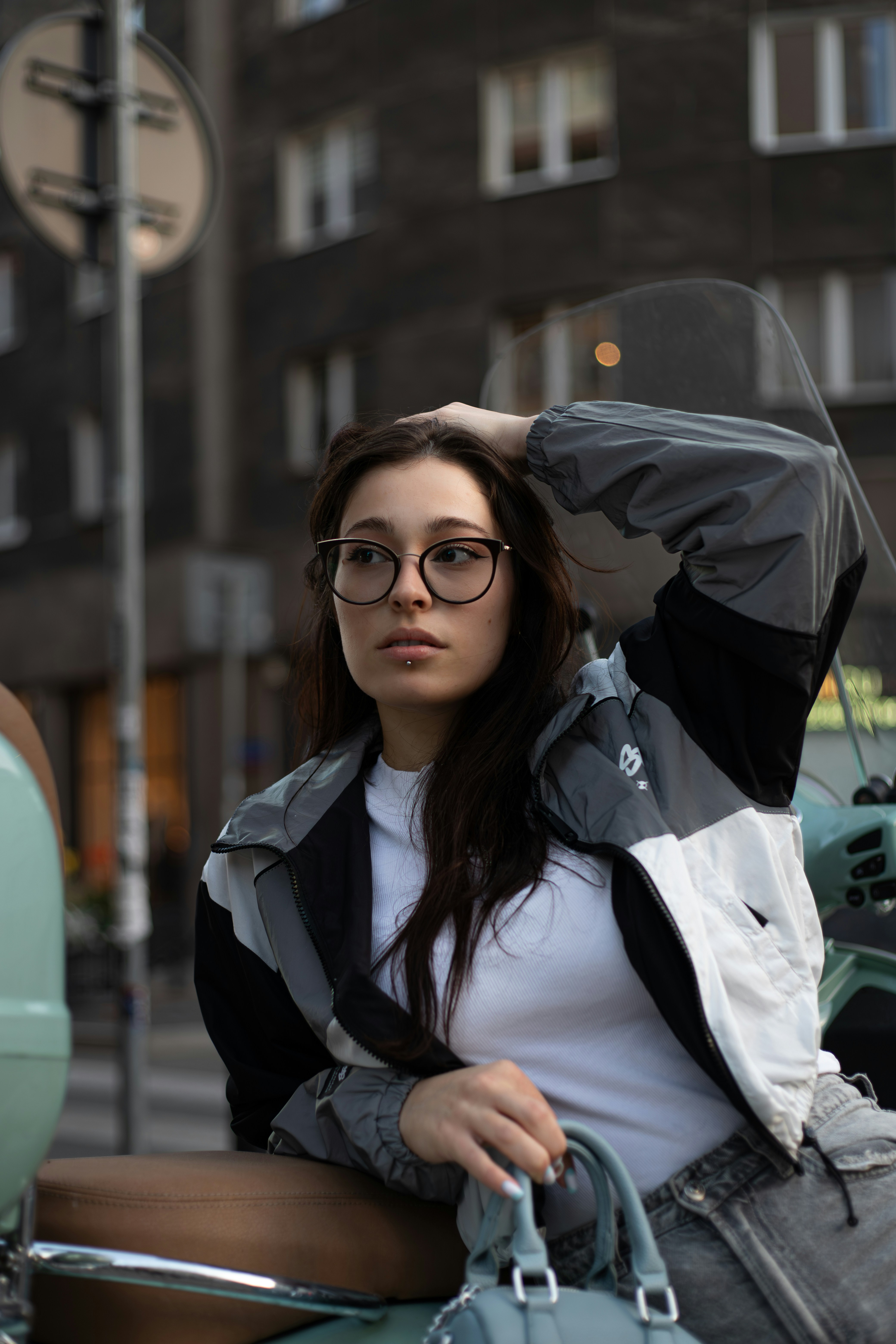Glasses, City Light: A Casual Portrait in Urban Soft Focus