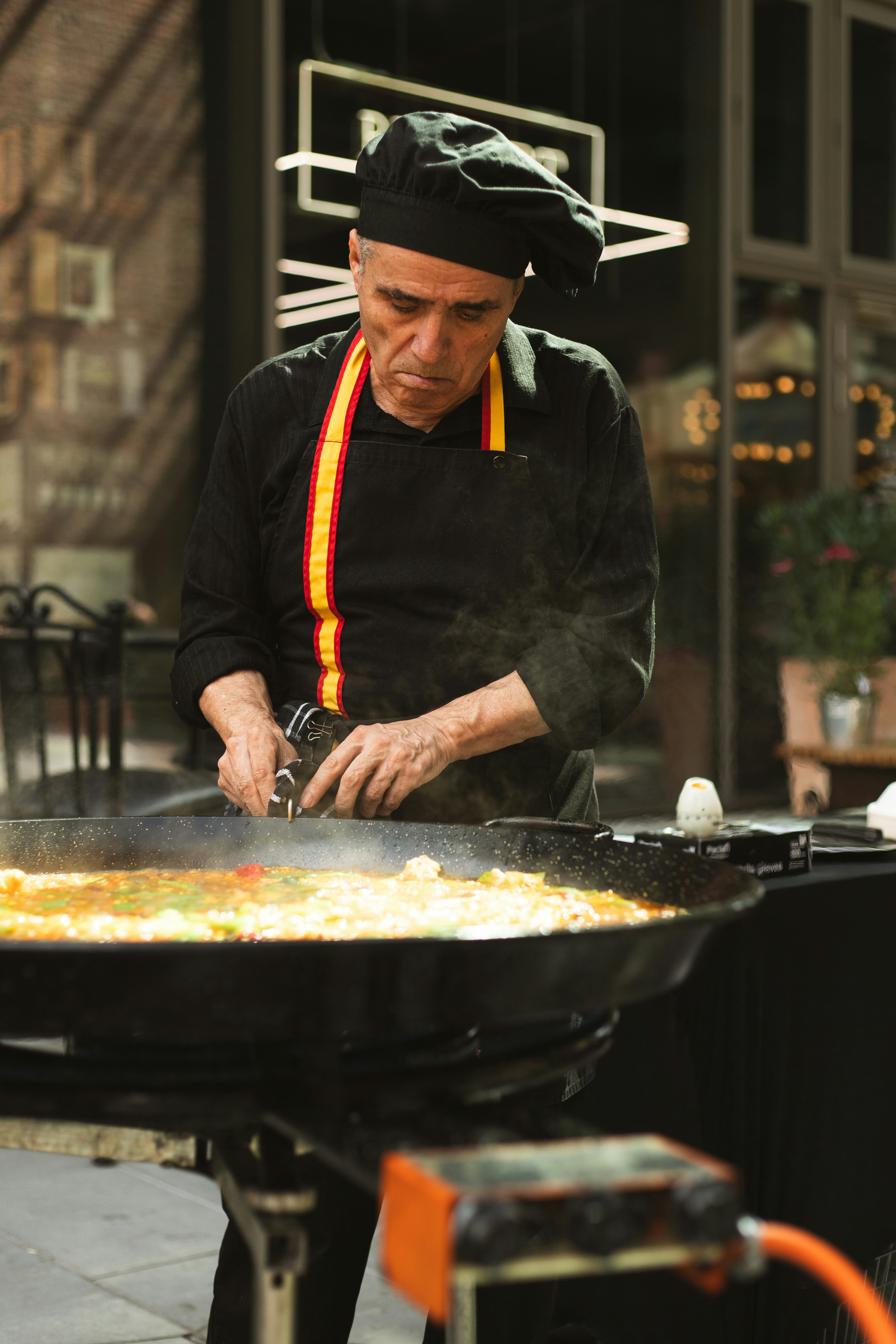 Sizzle and Steam: Street-Front Paella Master at Work