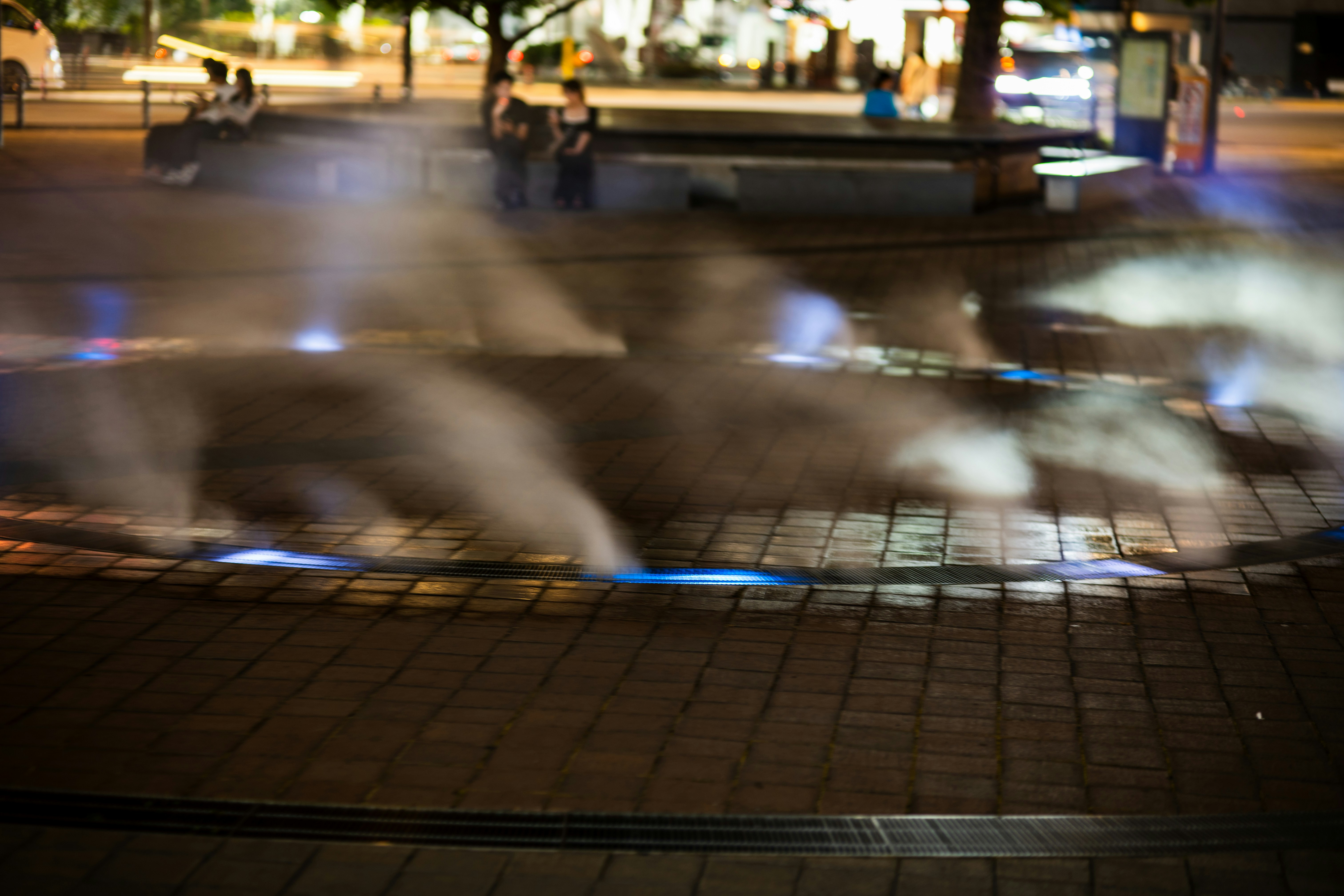 Blue Veil Over a Quiet City Plaza Fountain at Night