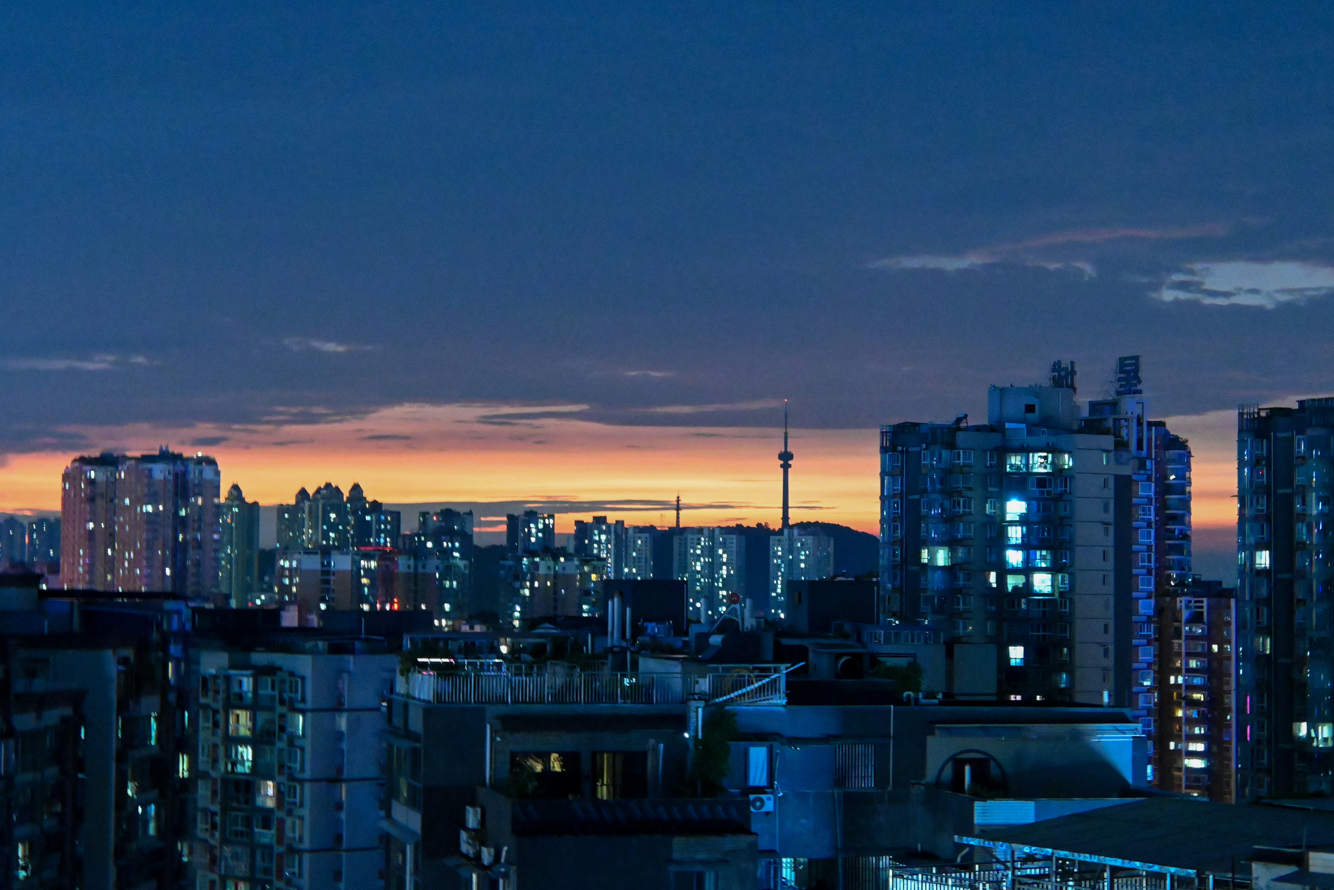 A view of a city skyline at night photo – Free Zigong Image on Unsplash
