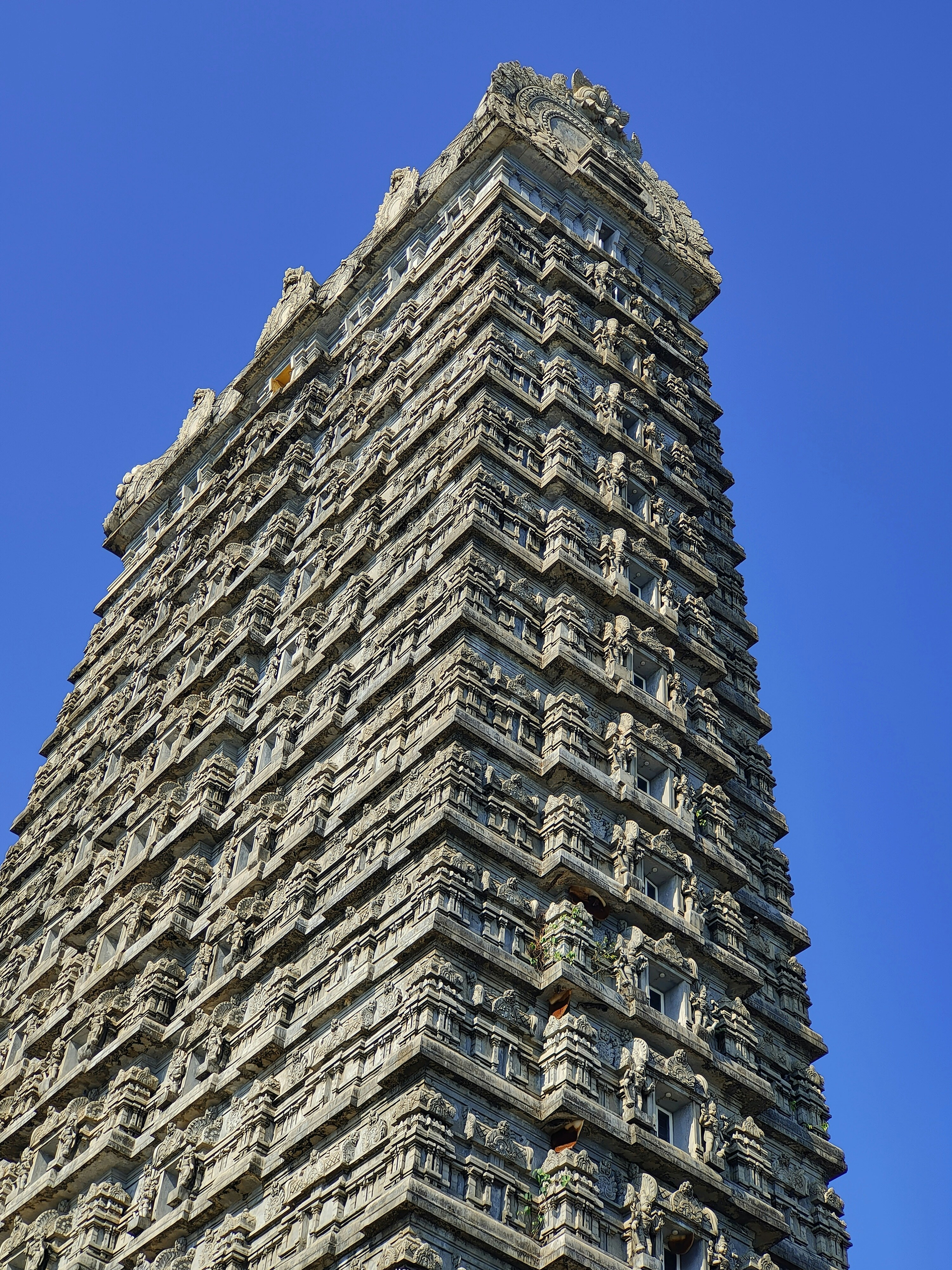 A very tall building with a clock on it's side photo – Free Karnataka ...