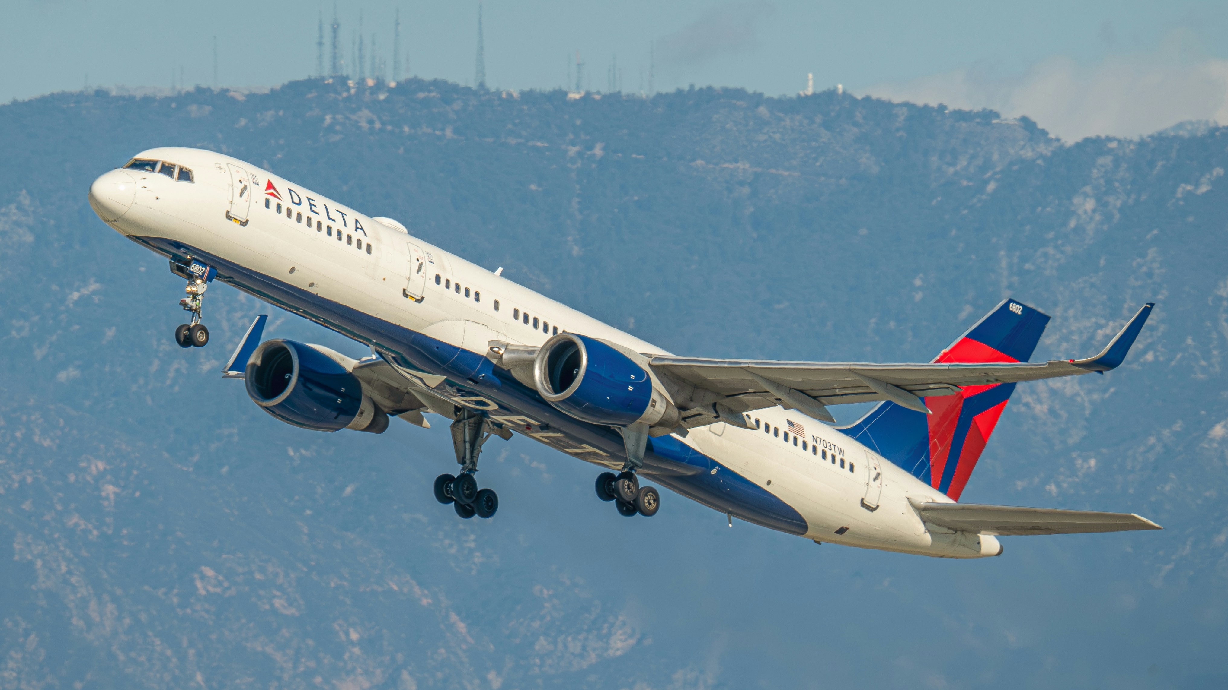 A large jetliner flying through a blue sky photo – Free Wallpaper 4k ...