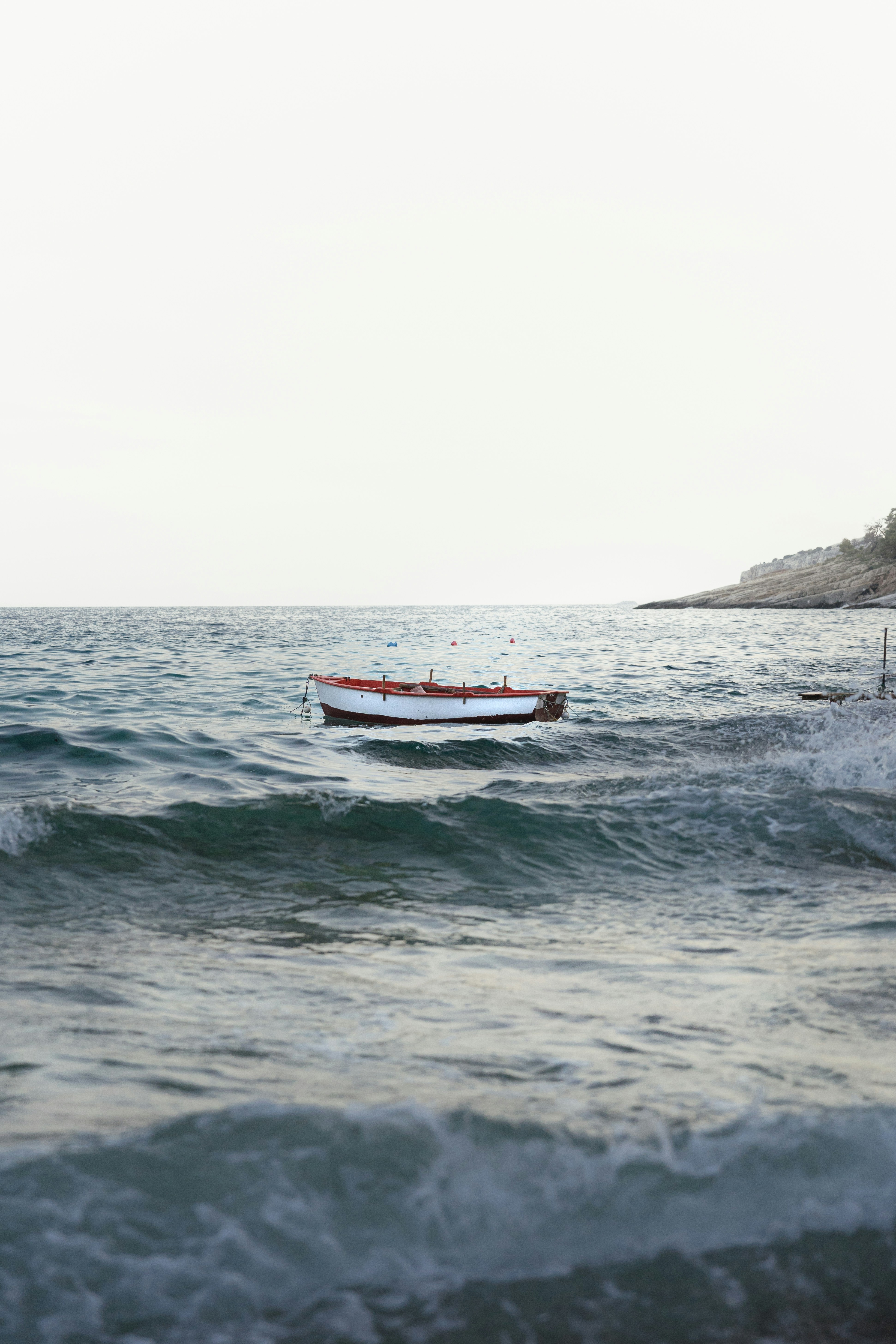 Red-and-White Boat Skimming Coastal Blues