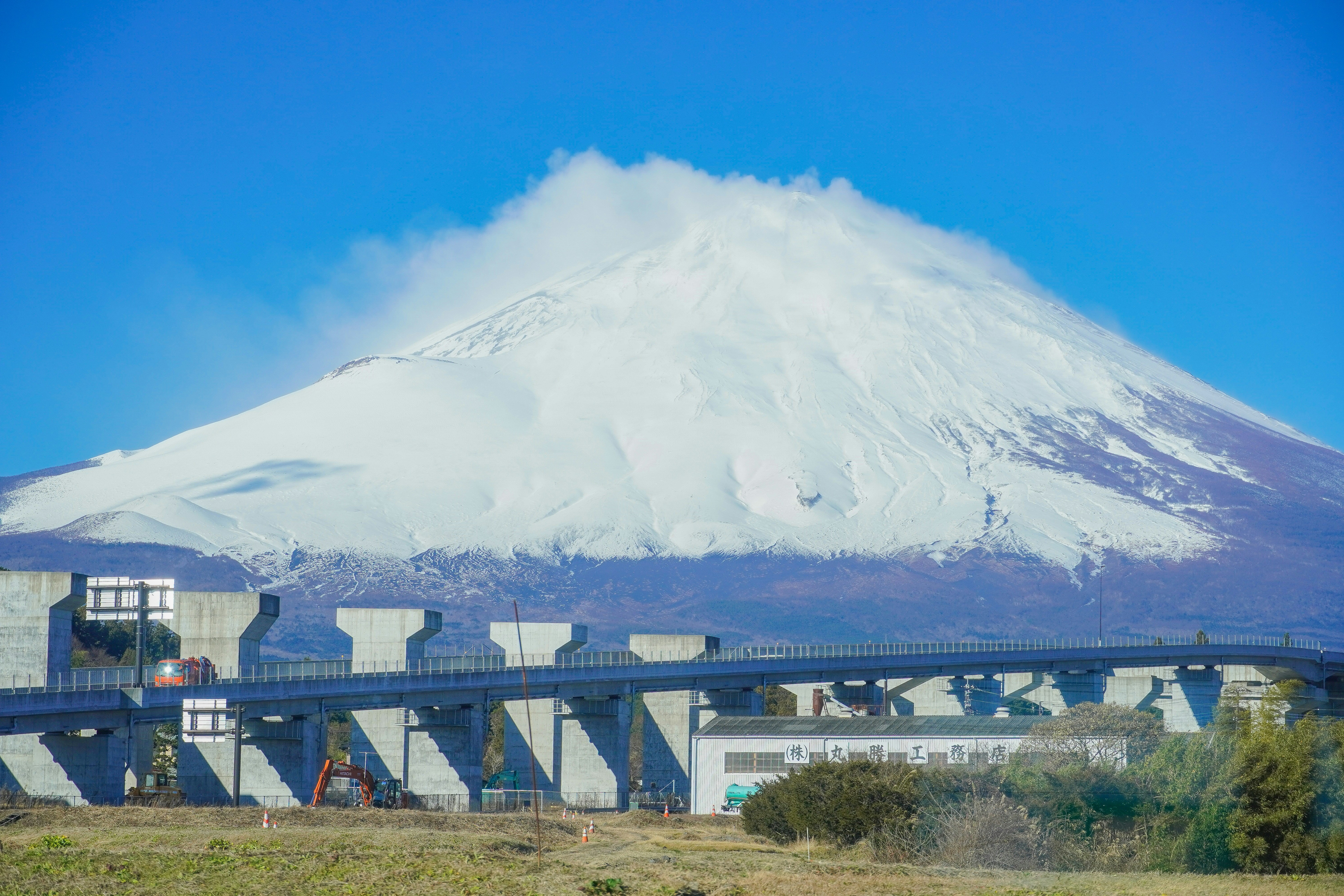 Snow-Capped Fuji Behind a Blue Railway Viaduct