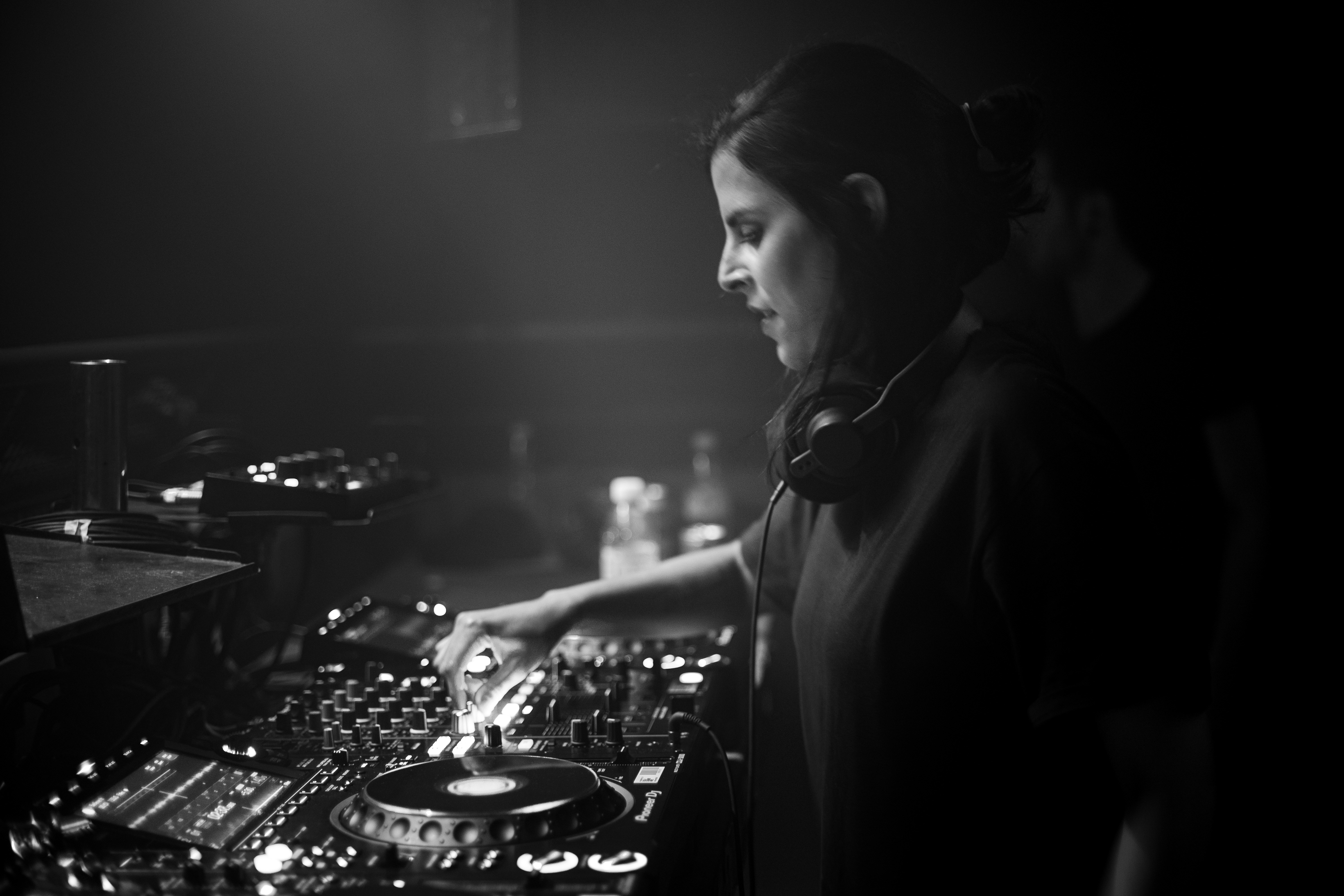 Un dj mezclando música en una habitación oscura foto – Imagen de Adulto ...