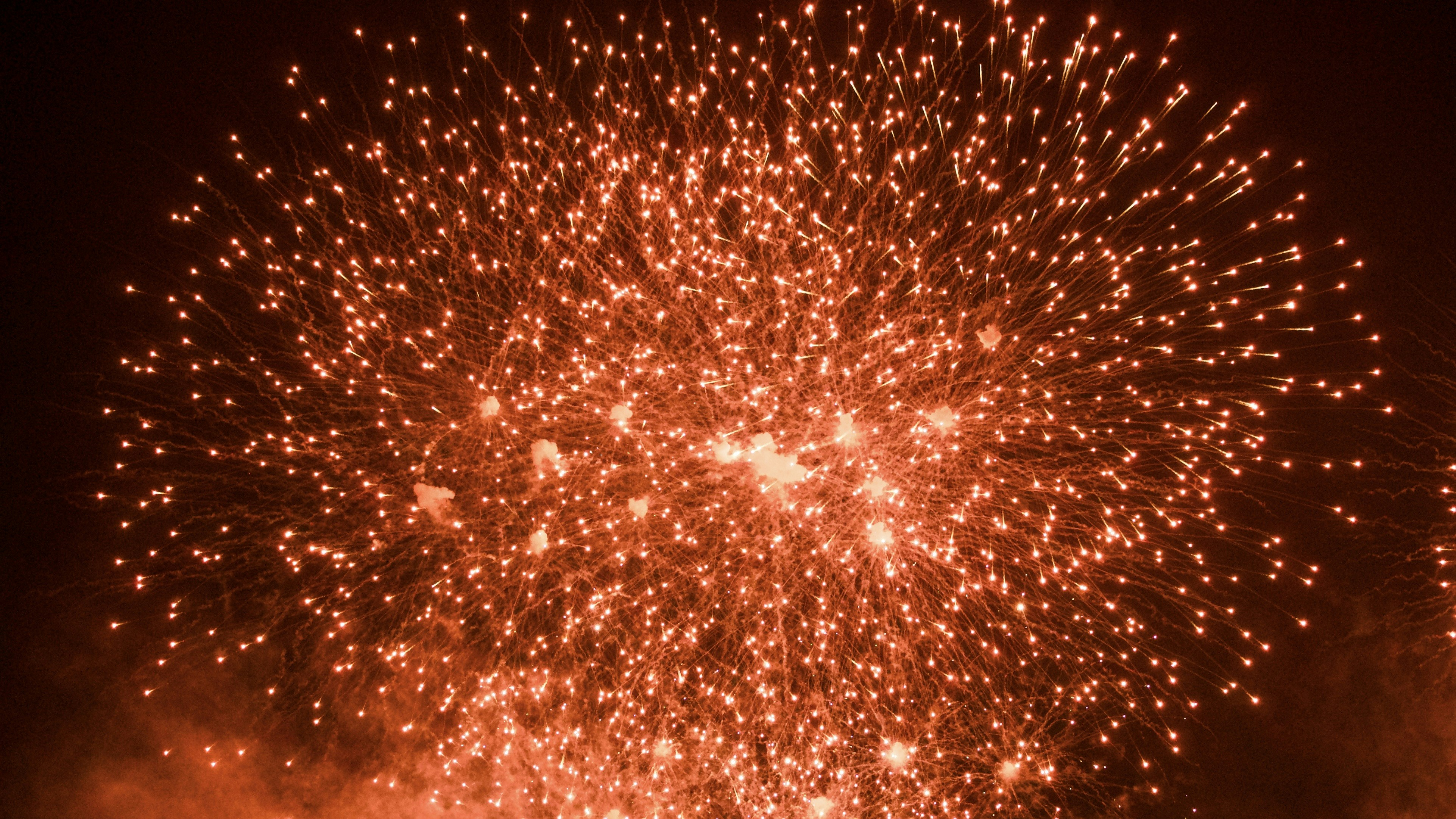 A large red fireworks is lit up in the night sky photo – Free Fireworks ...