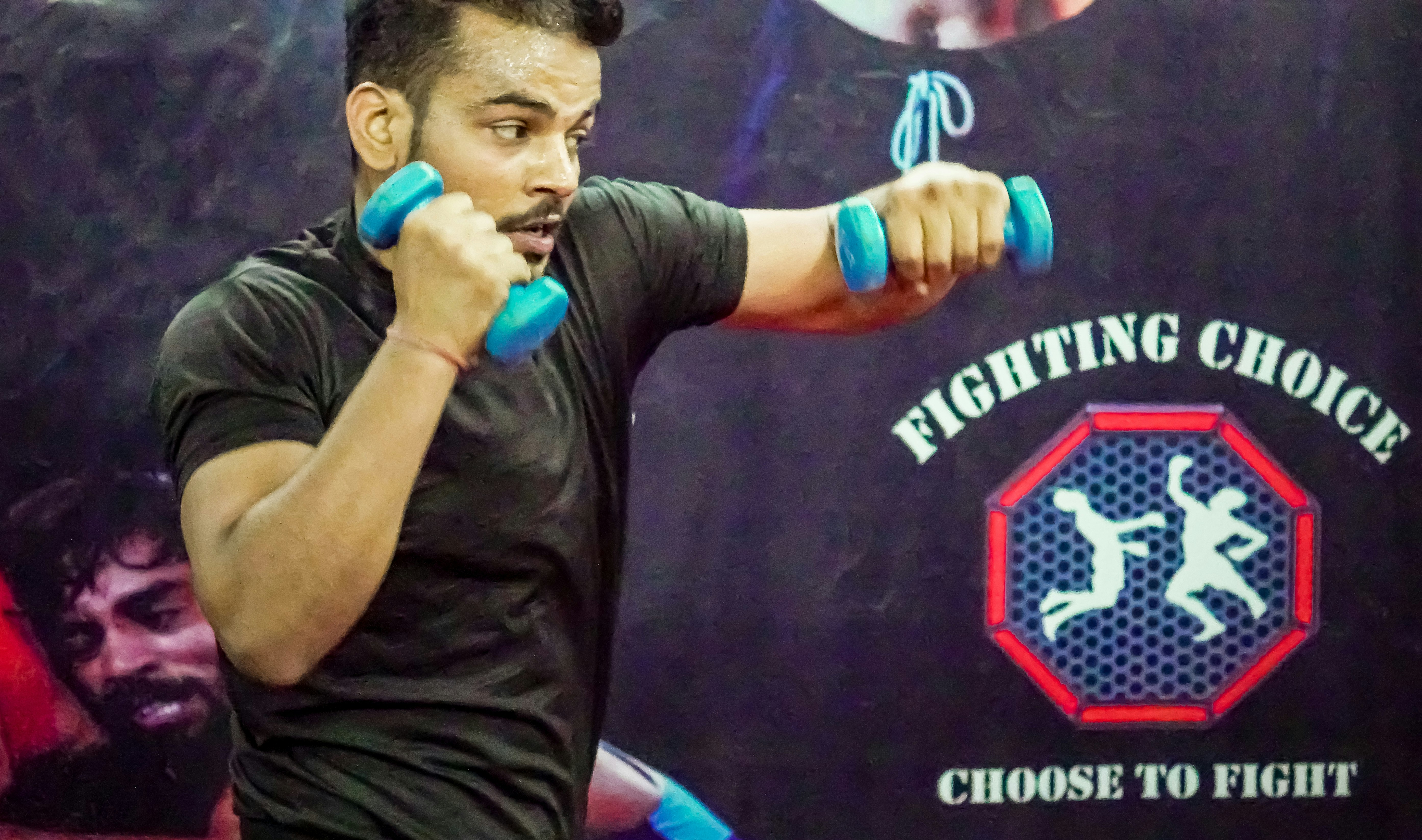 A man holding a pair of blue dumbs photo – Free Fighting choice gr noida Image on Unsplash