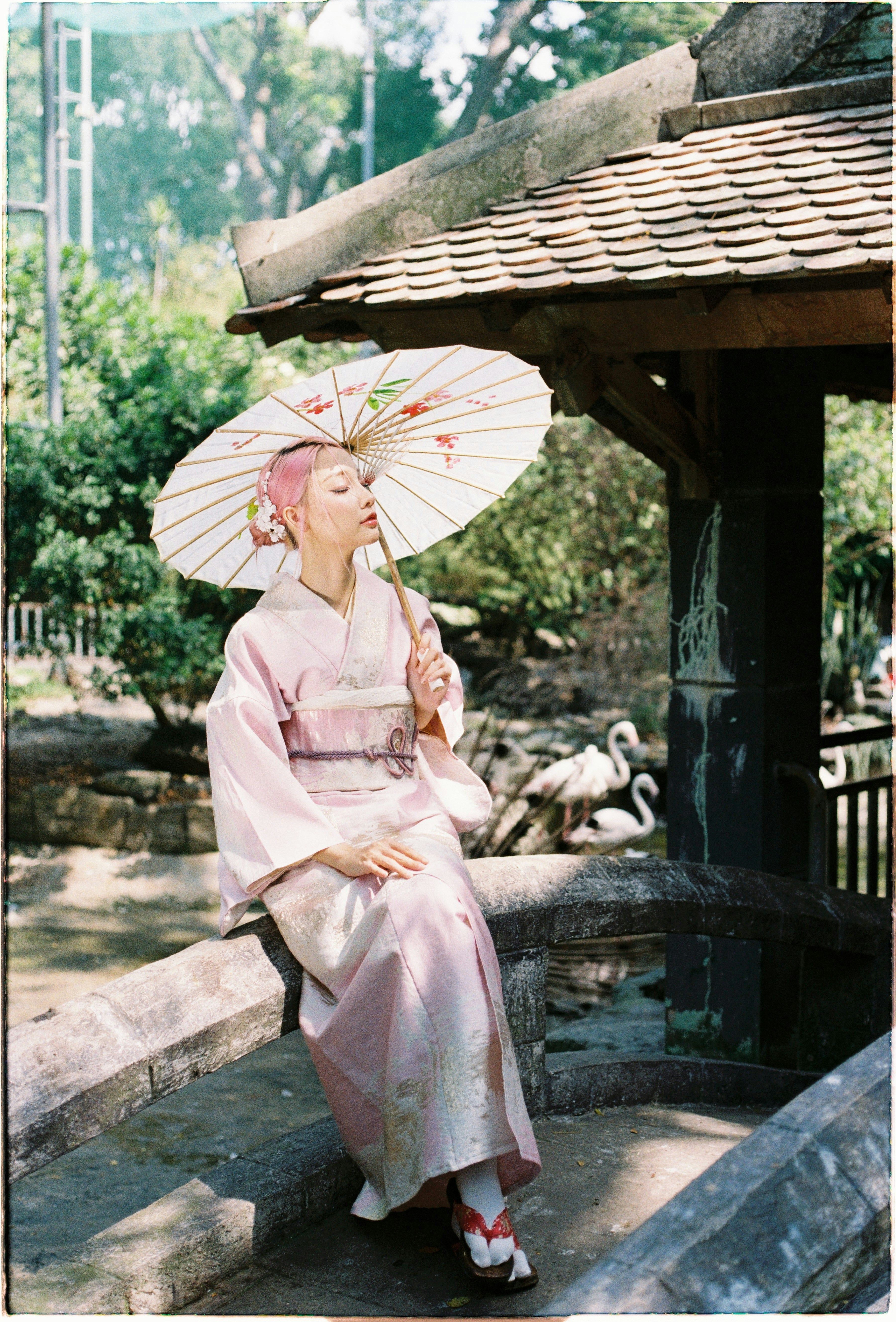 Pastel Kimono and Floral Parasol on a Tranquil Stone Bridge