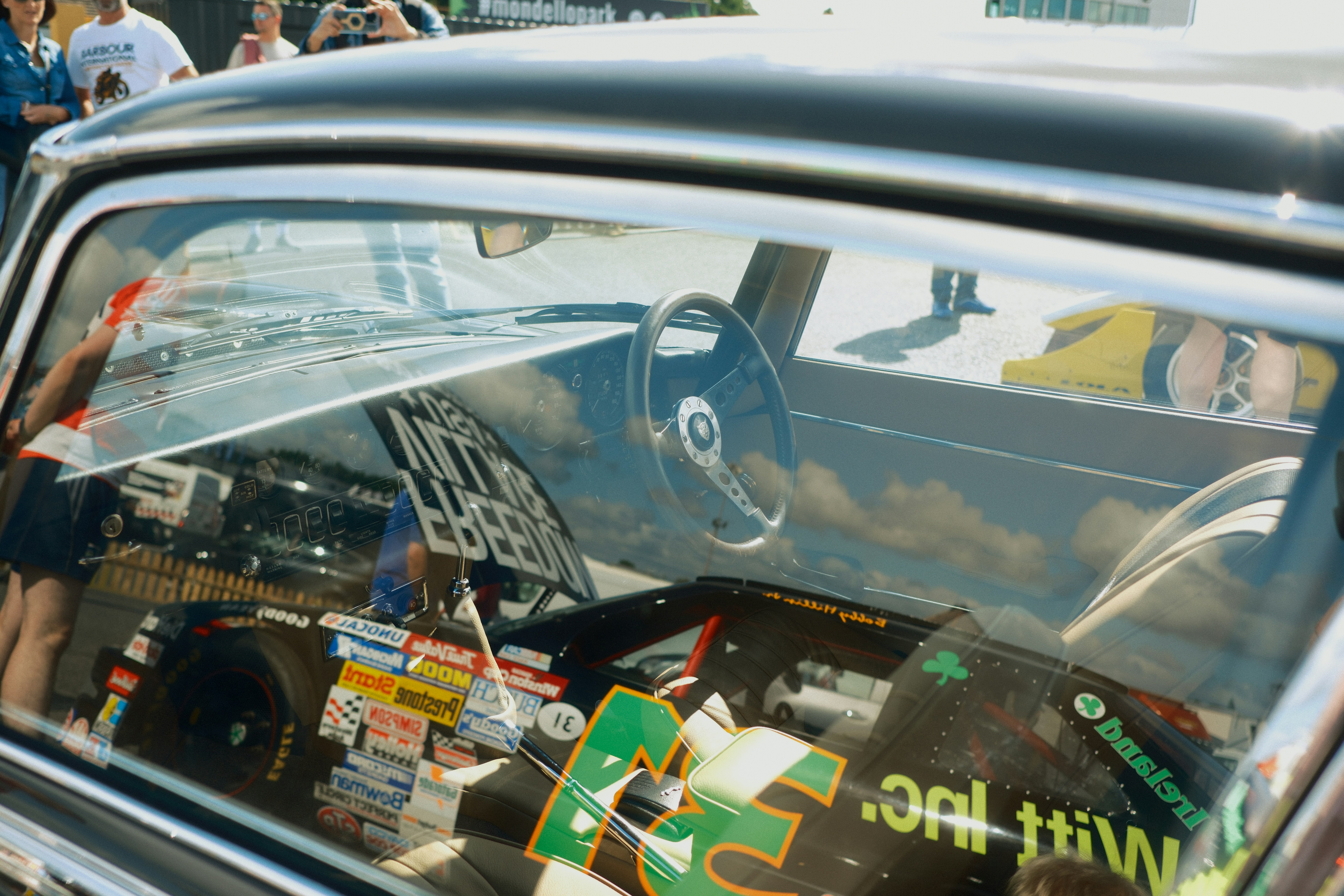 Stickered Spectacle: Inside a Vintage Race Car Through the Glass