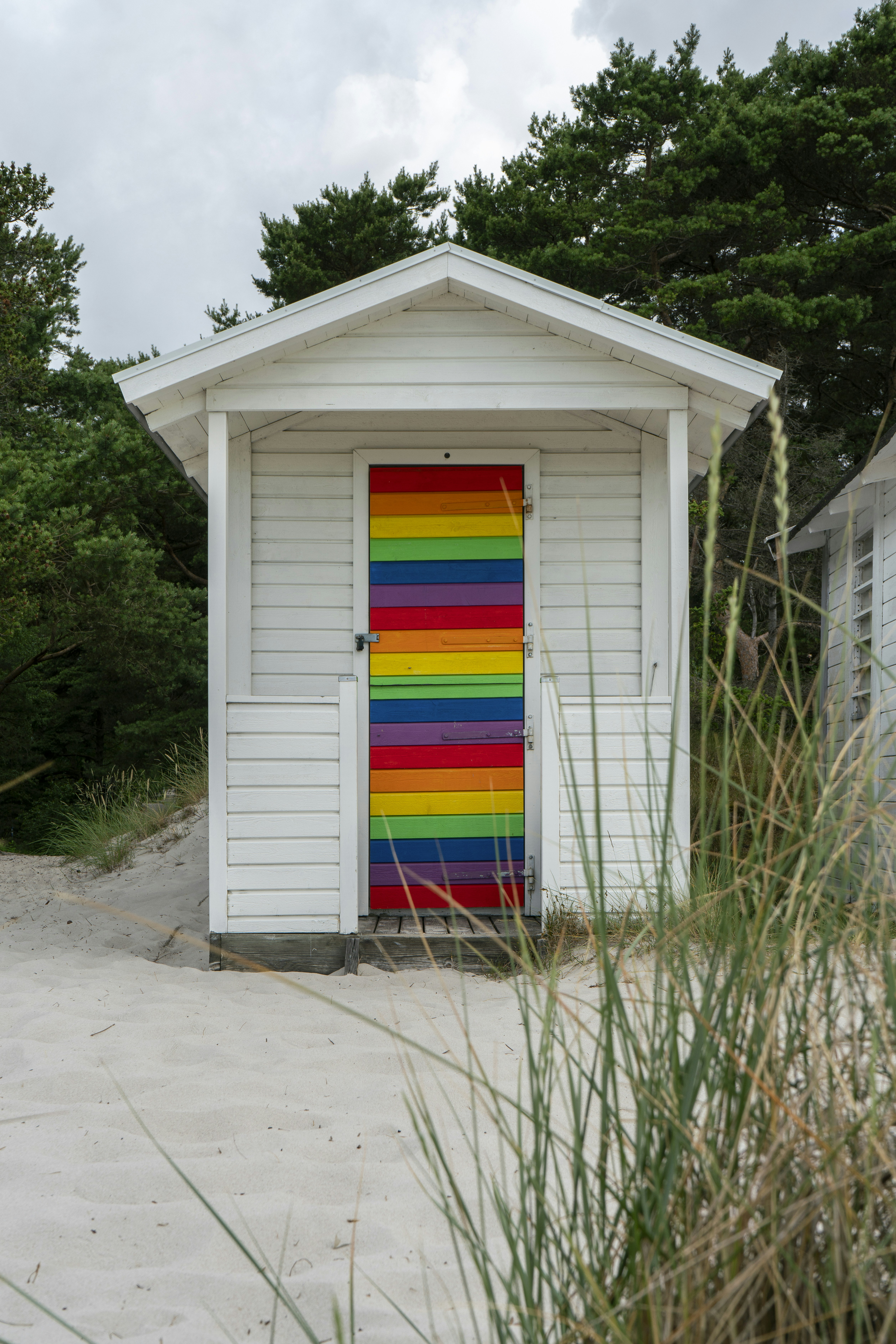 Rainbow Door on a Serene Beach Hut